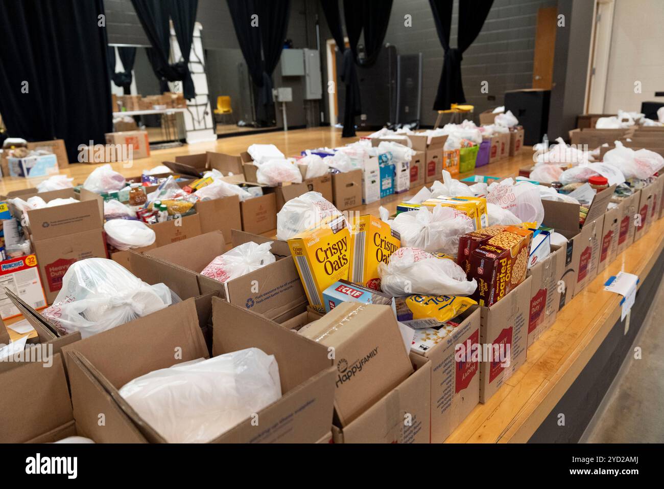 Boxes of food items line the stage in an auditorium of the Dr. Wesley ...