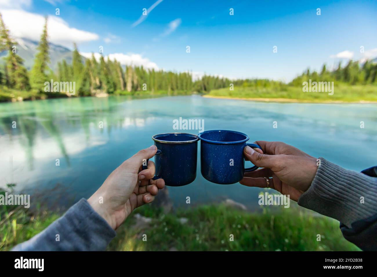 Two people drinking coffee in a forest Stock Photo - Alamy