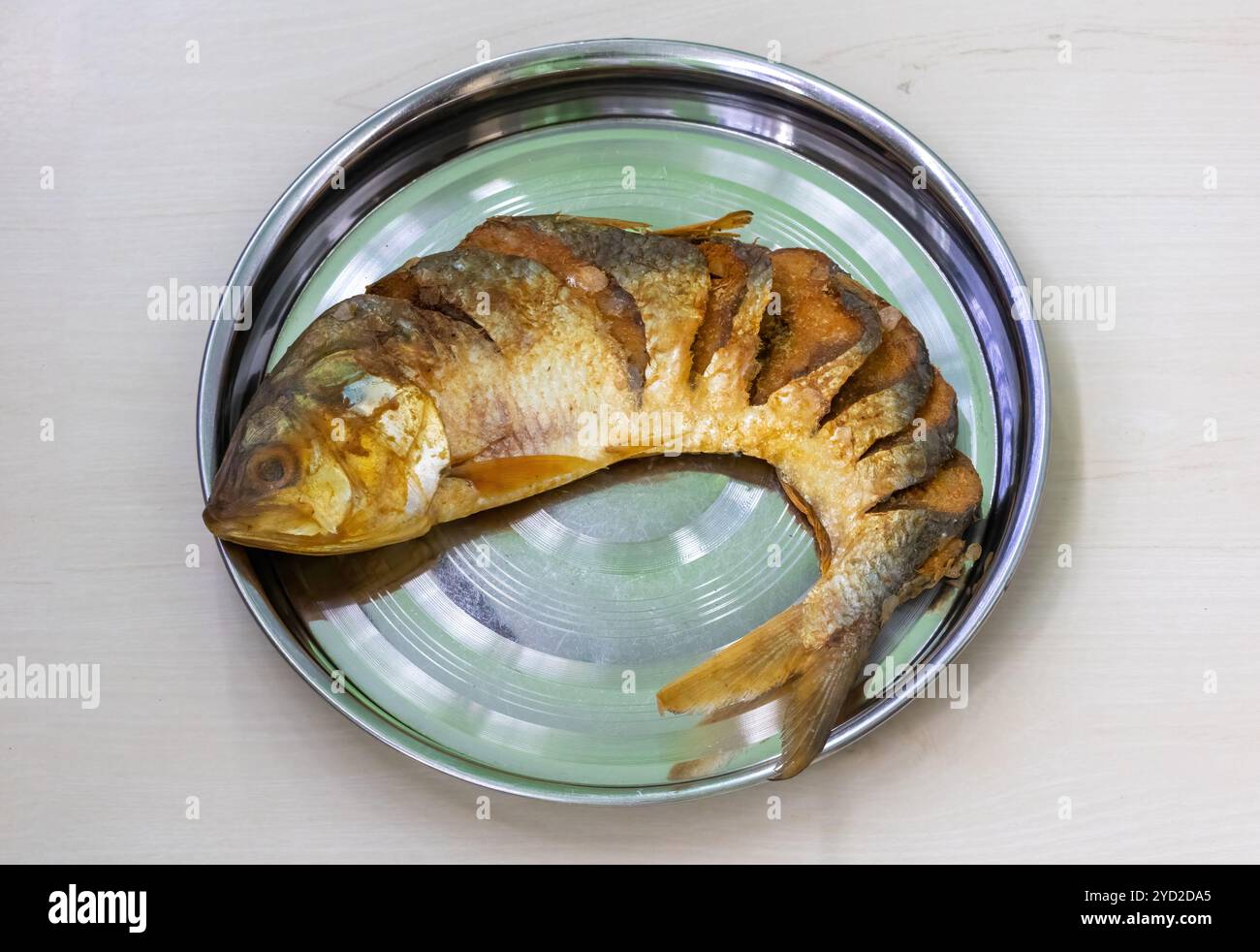 Salted Hilsa fish on a steel plate. It is very delicious and popular ...