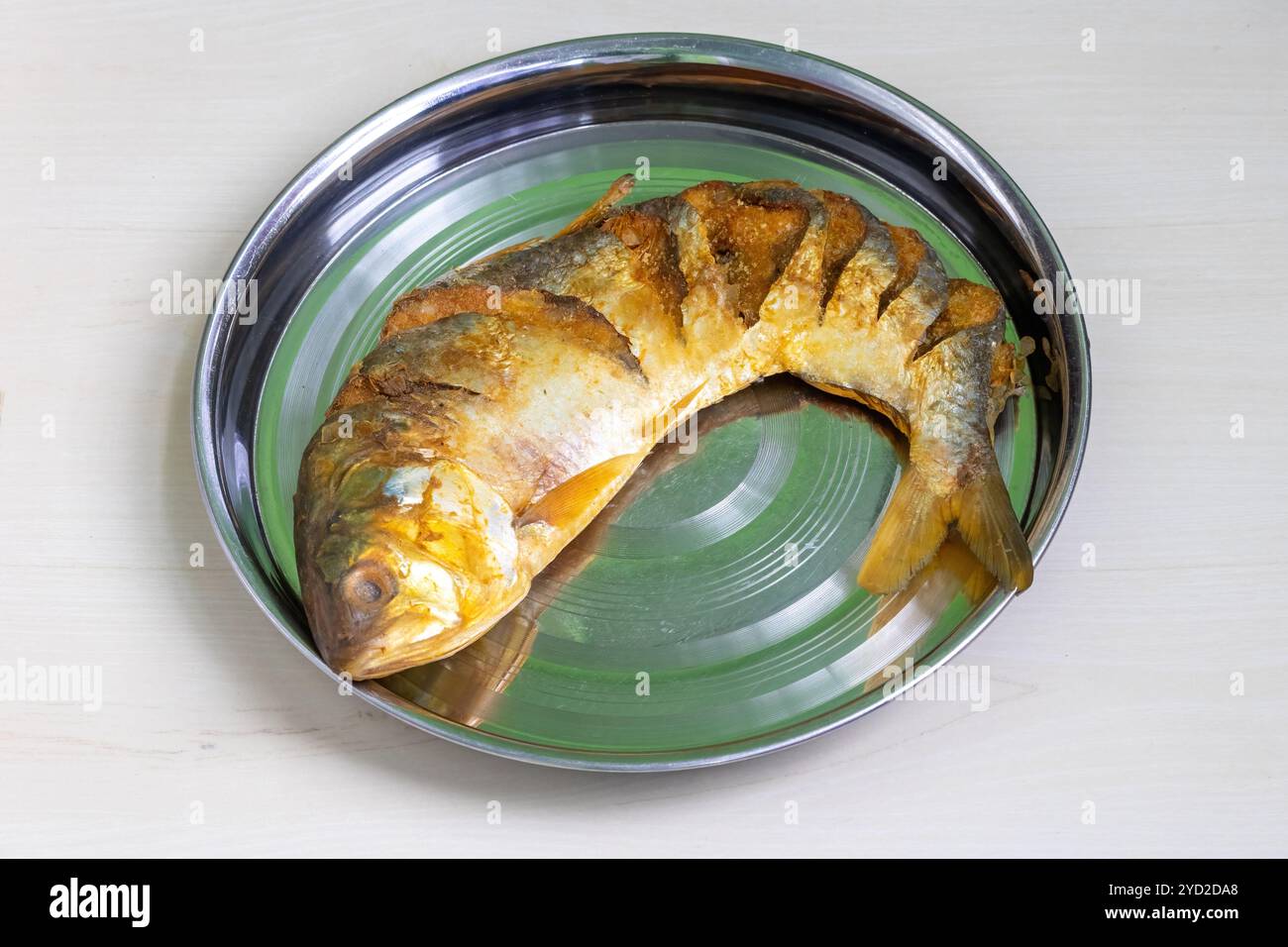 Salted hilsa fish on steel plate. It is a very popular dry fish of ...