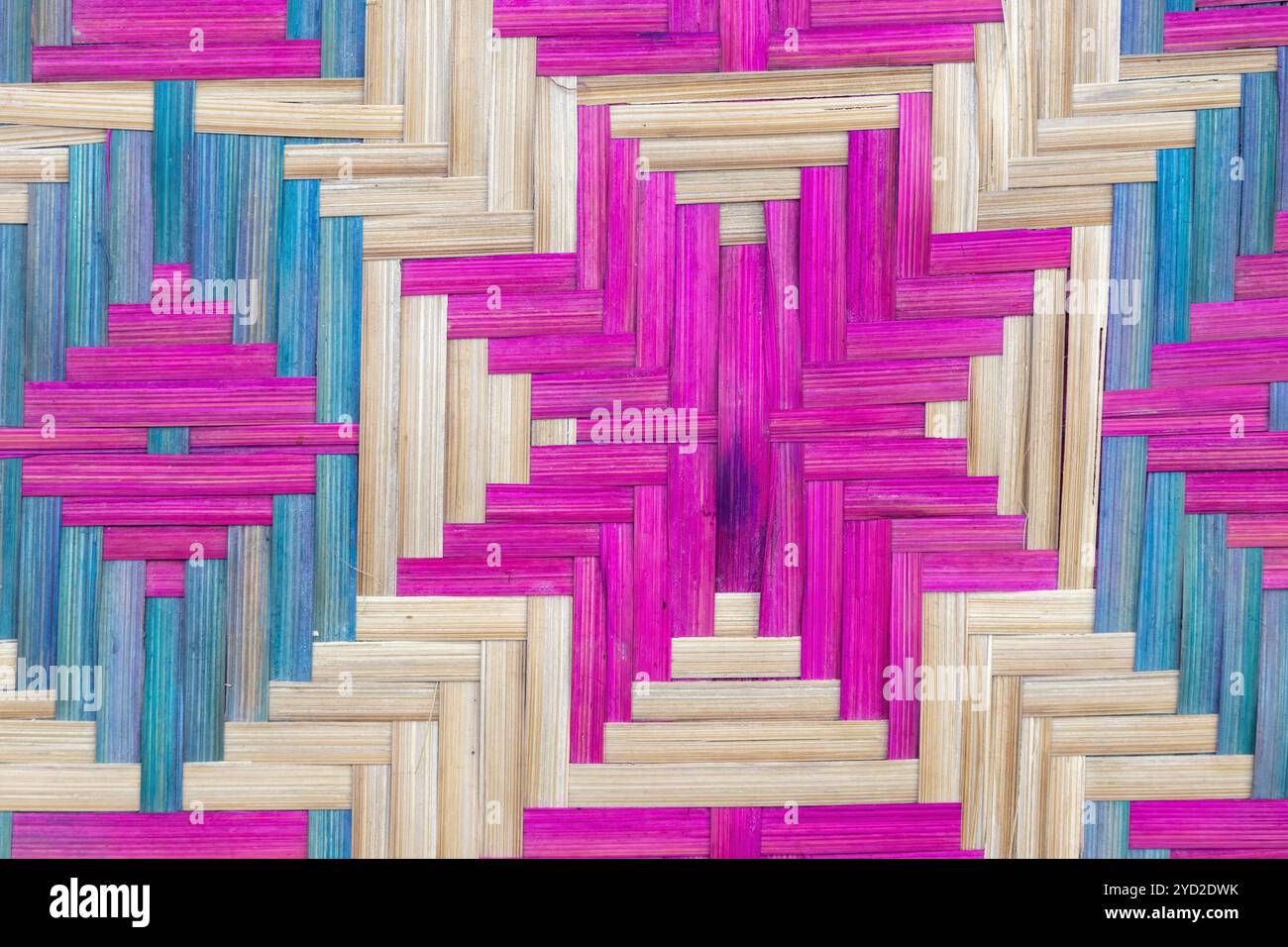Close-up of a wicker handmade fan with a colorful bamboo weave ...