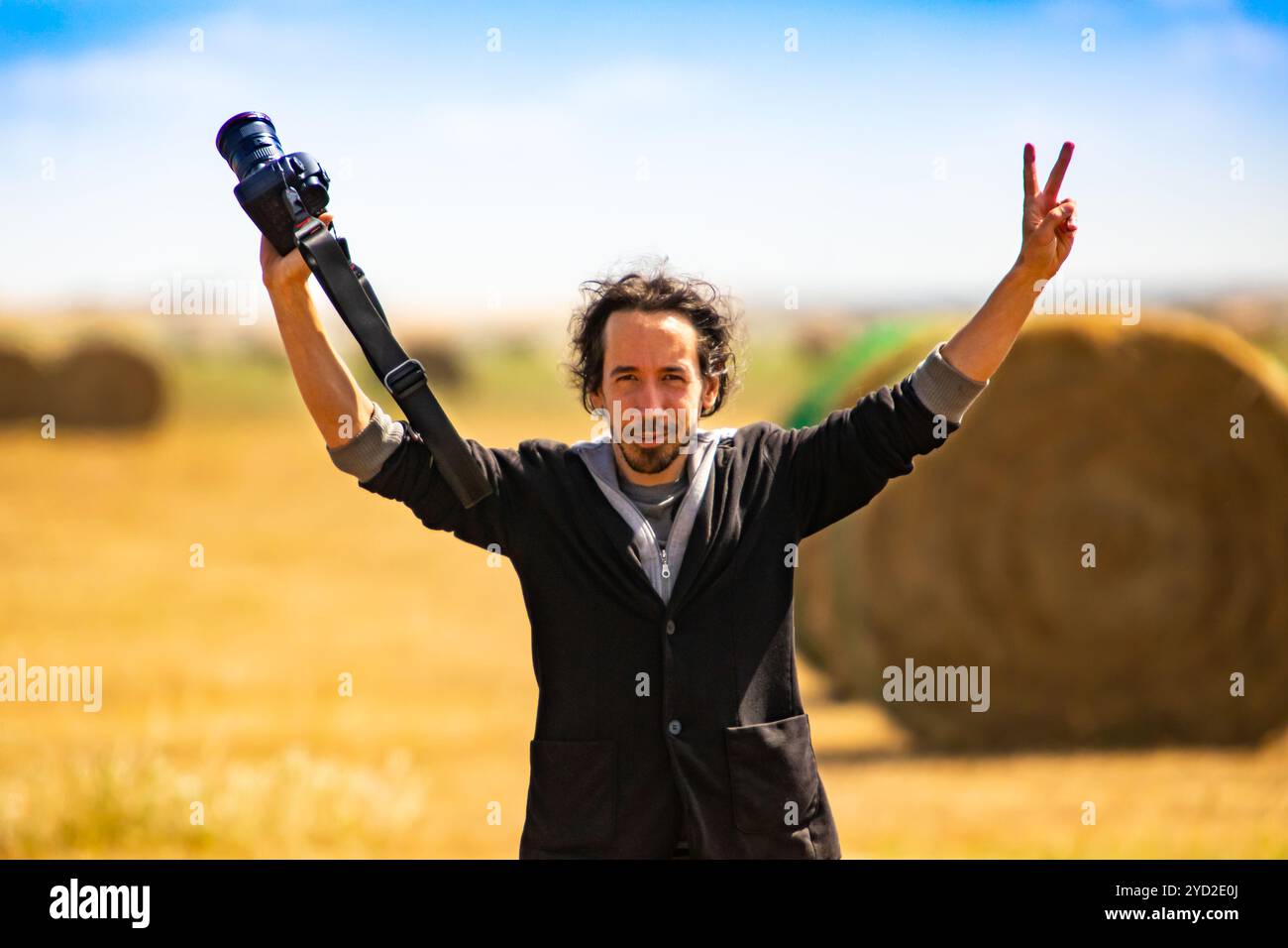 Successful photographer victory sign Stock Photo - Alamy