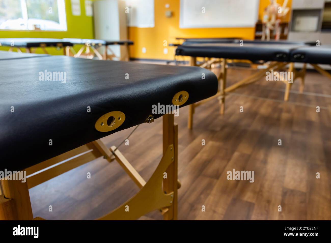 Empty tables in massage training room Stock Photo - Alamy