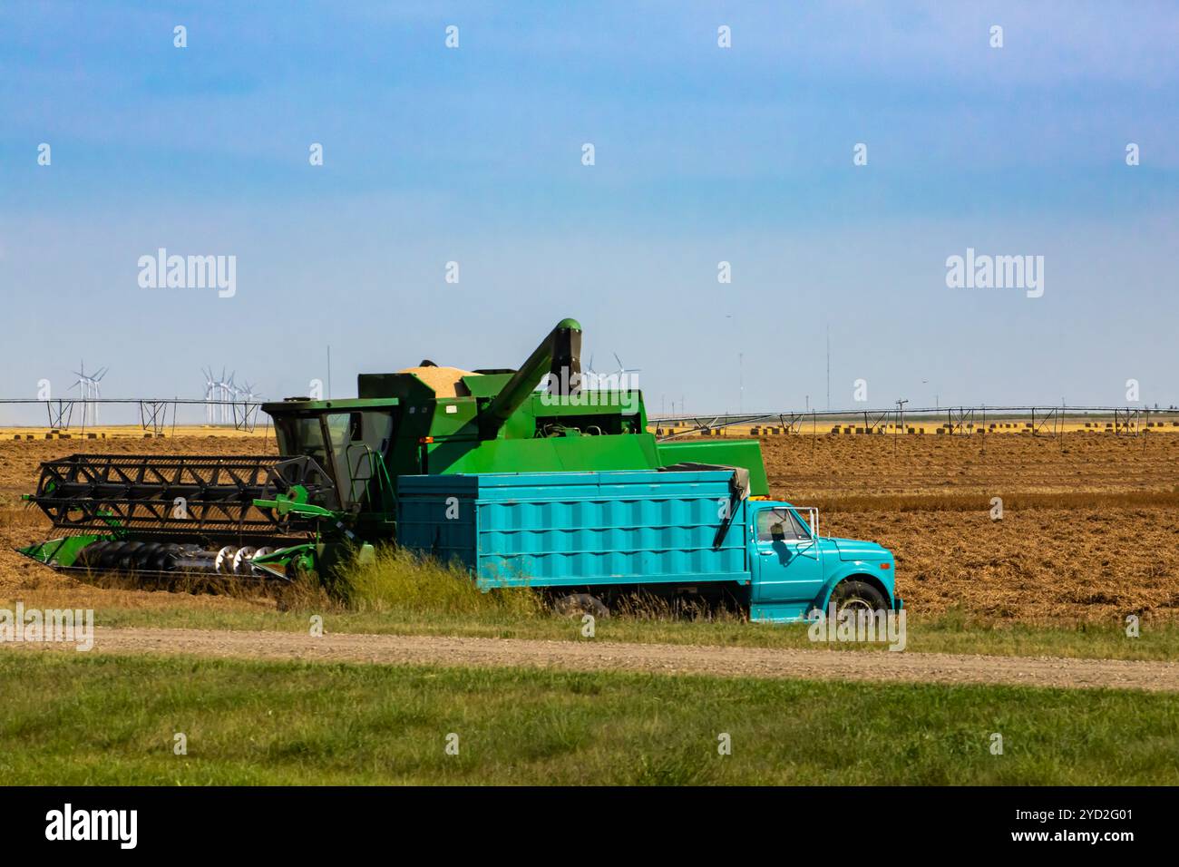 Farm vehicles at work in crop field Stock Photo - Alamy