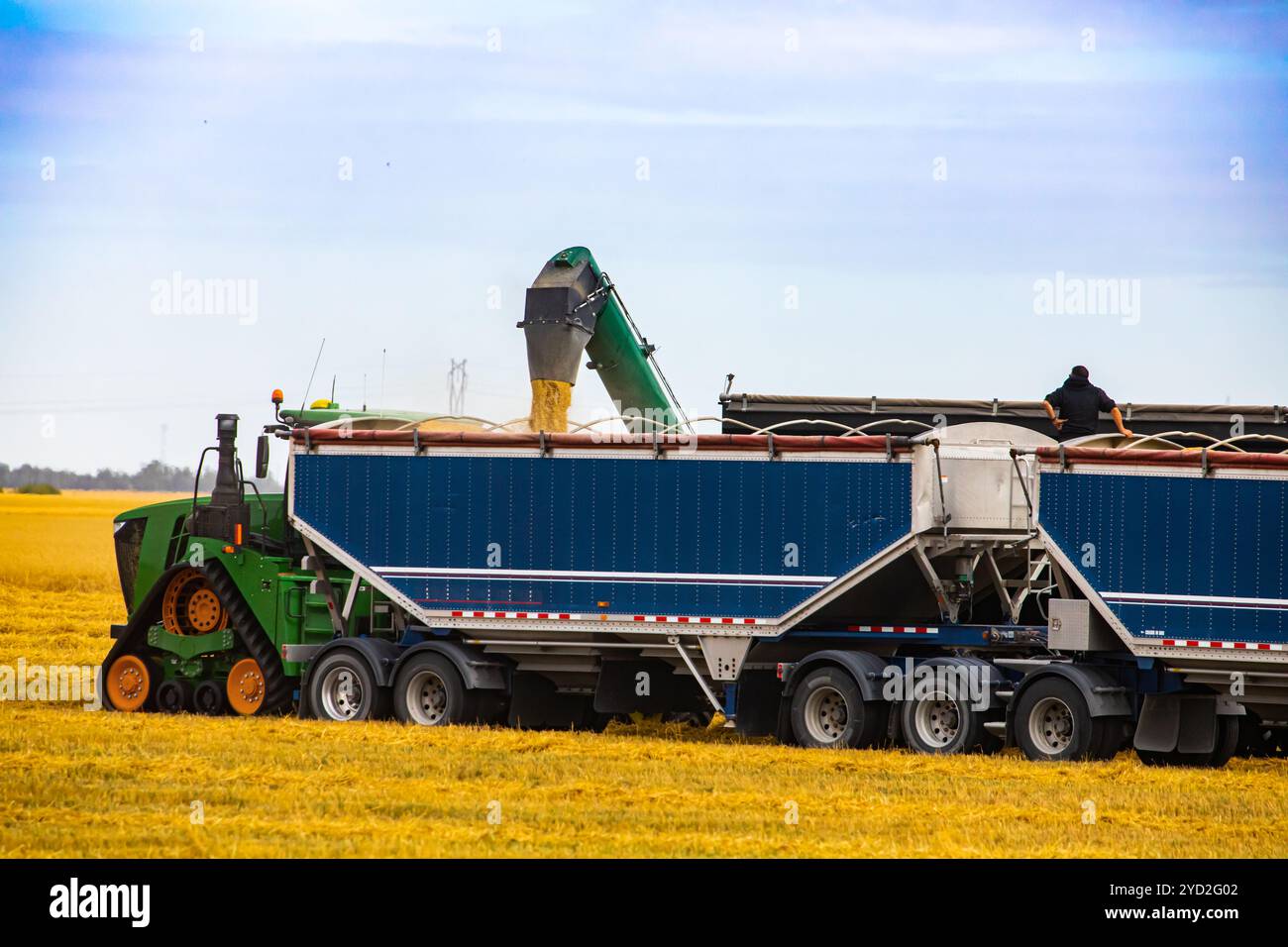 Farm vehicles at work in crop field Stock Photo - Alamy