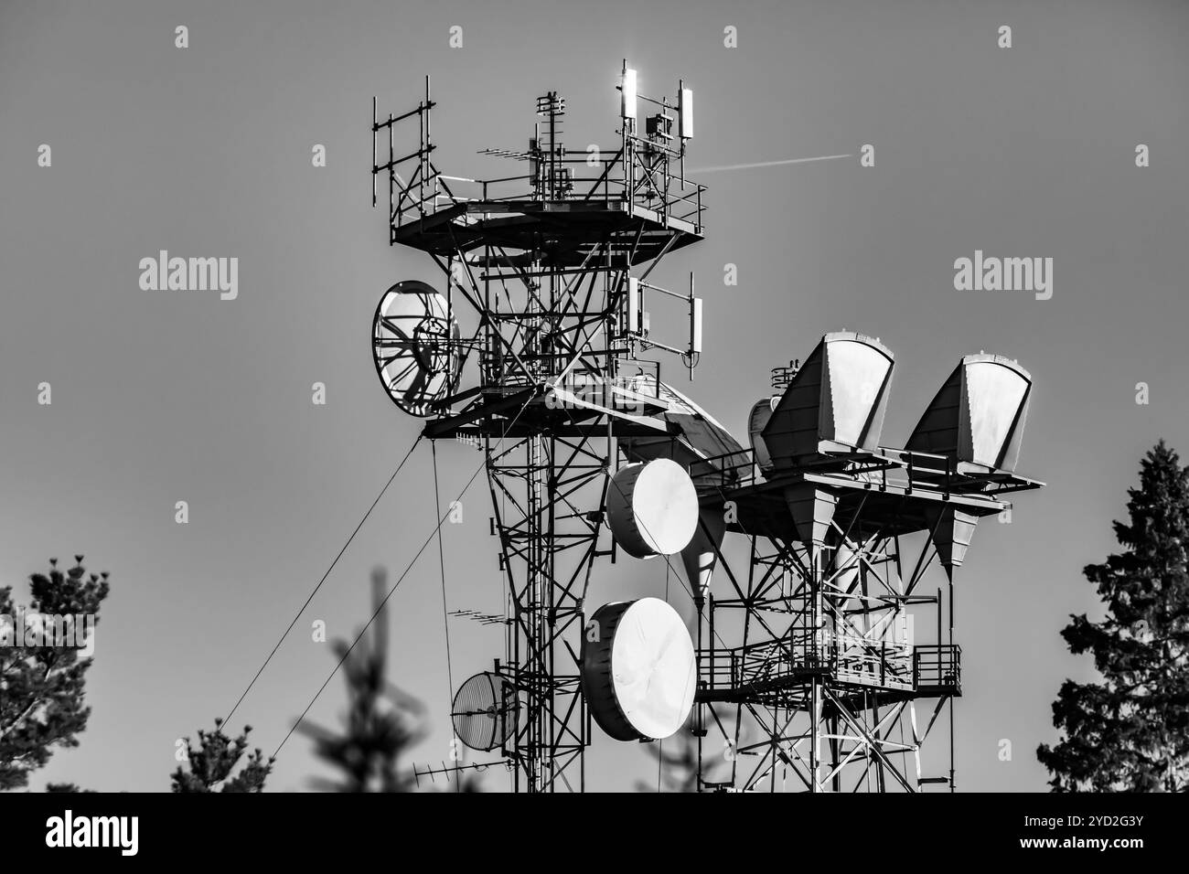 A black and white view of a modern cellular network base station, two ...