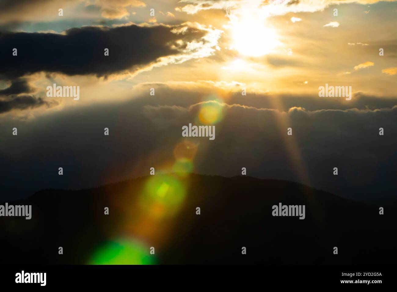 Sunrise over mountains with lens flares Stock Photo - Alamy