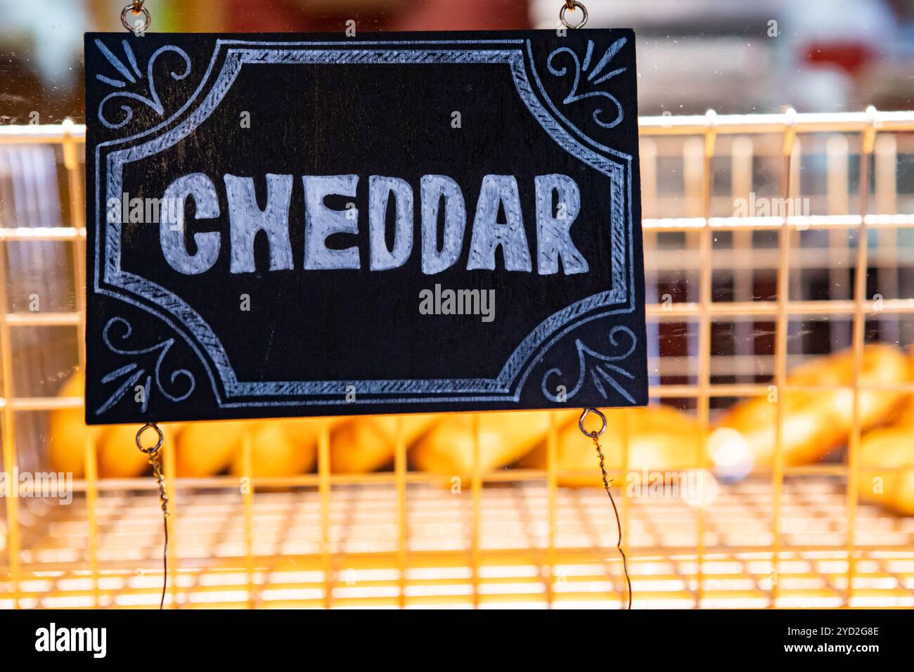Cheddar text hanging on glass counter Stock Photo - Alamy