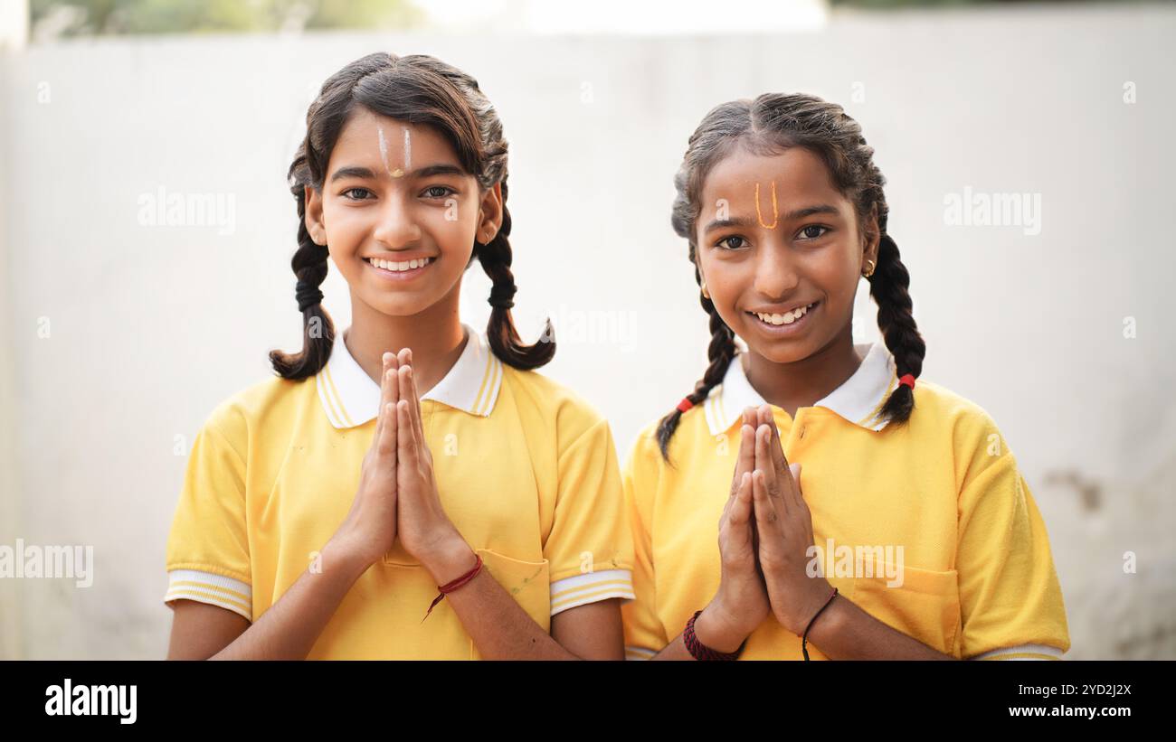 Portrait of happy indian school child sitting at desk in classroom ...