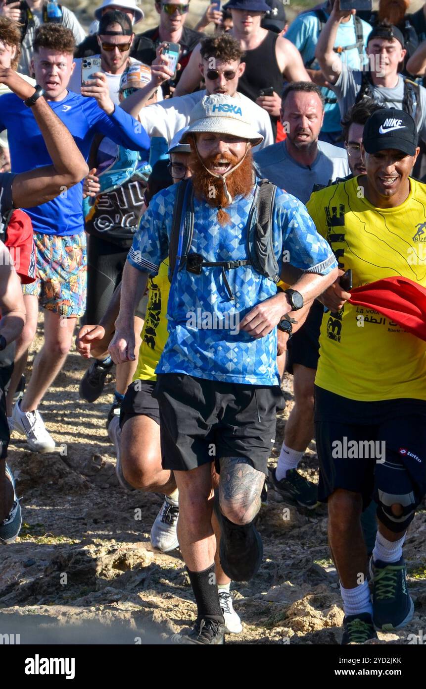 Cape Angela, Tunisia. 07 April 2024. Russ Cook runs with his supporters ...