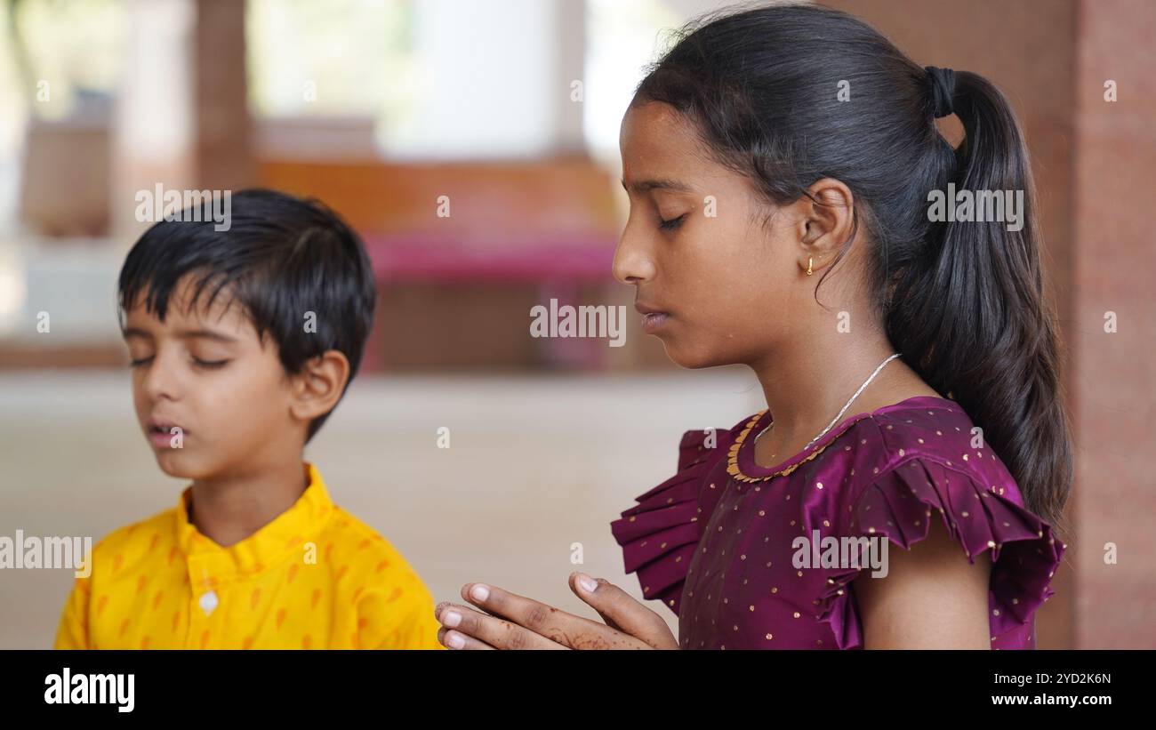 A Hindu family gathers around a sacred fire for Yagya during a festival ...