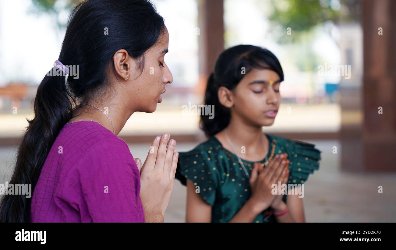 A Hindu family gathers around a sacred fire for Yagya during a festival ...