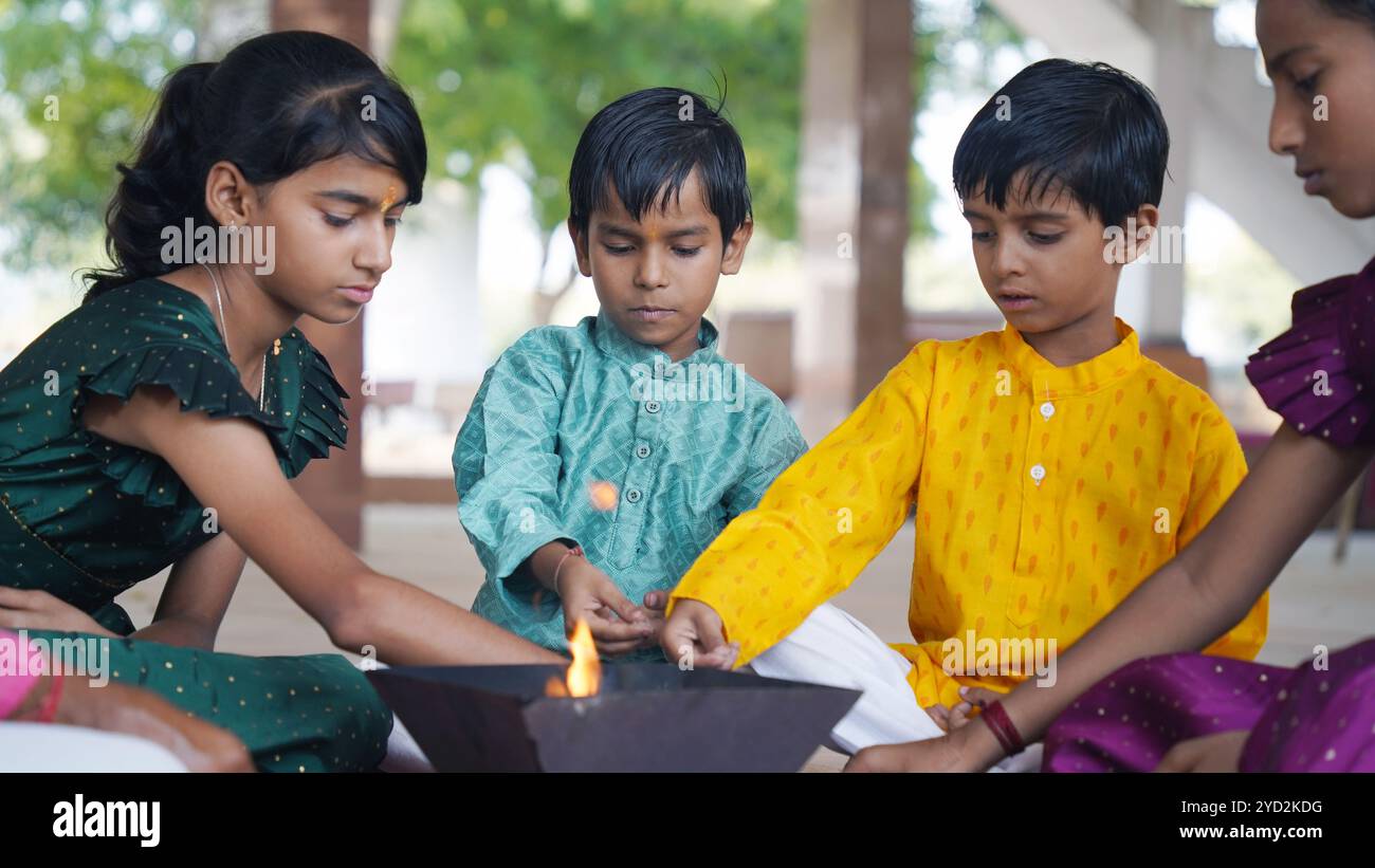 An Indian family in traditional attire performs a Yagya or Havan, led ...