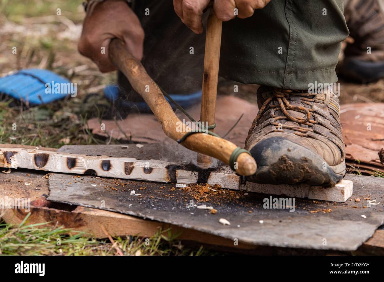 Man demonstrating native fire lighting method Stock Photo - Alamy