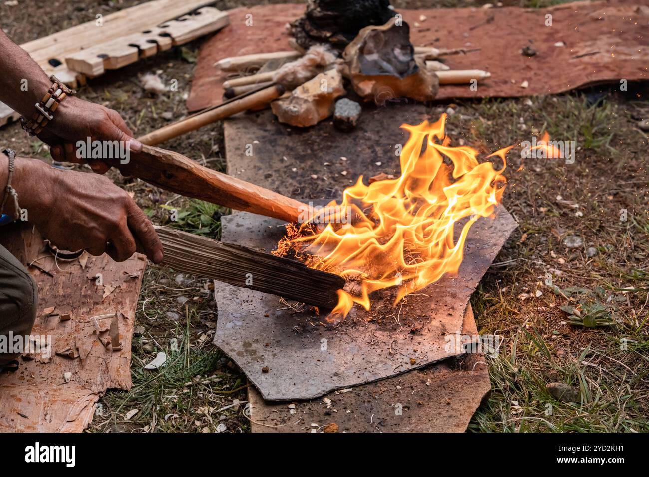 Man hand holding sticks in straw with fire Stock Photo - Alamy