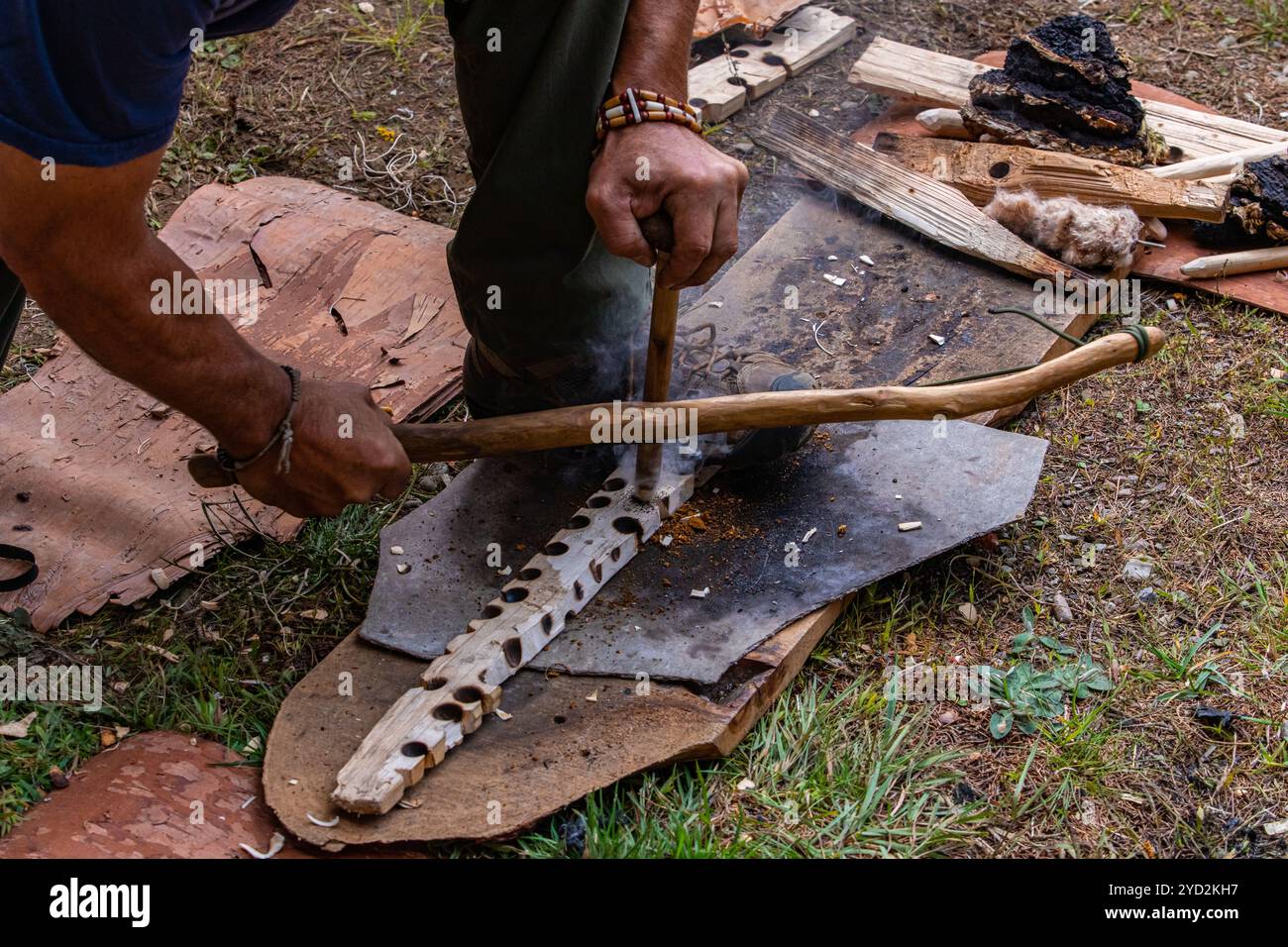 Man demonstrating native fire lighting method Stock Photo - Alamy