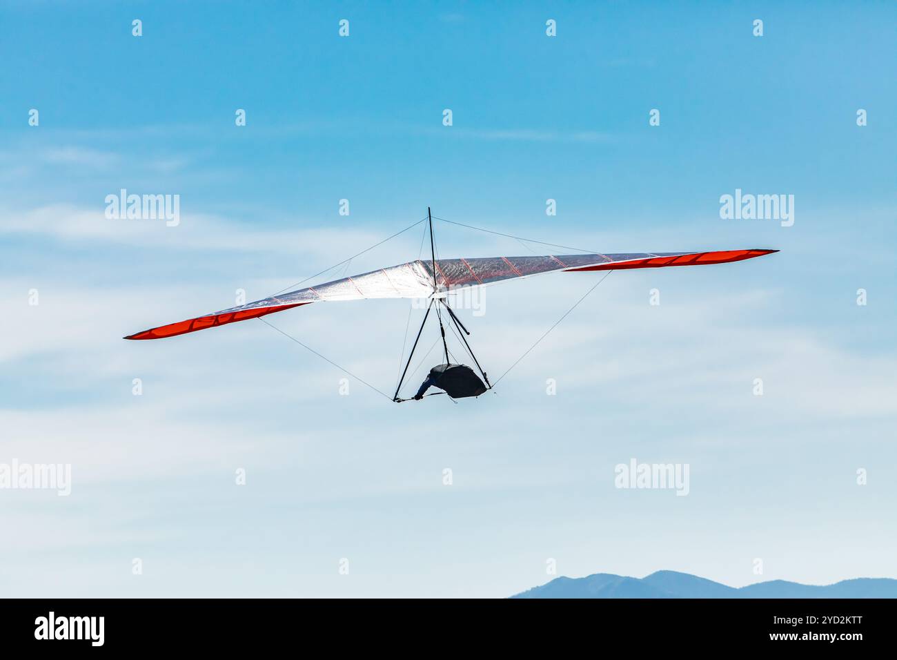 Hang gliding over valley farmlands and mountains Stock Photo - Alamy
