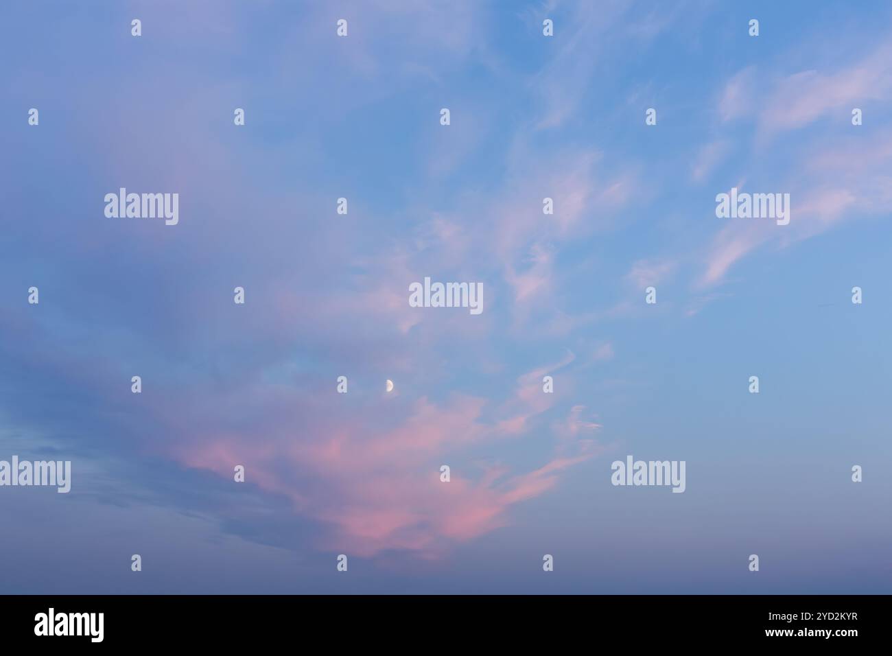Pastel western sky with crescent moon. A calm pastel sky at sunset with ...