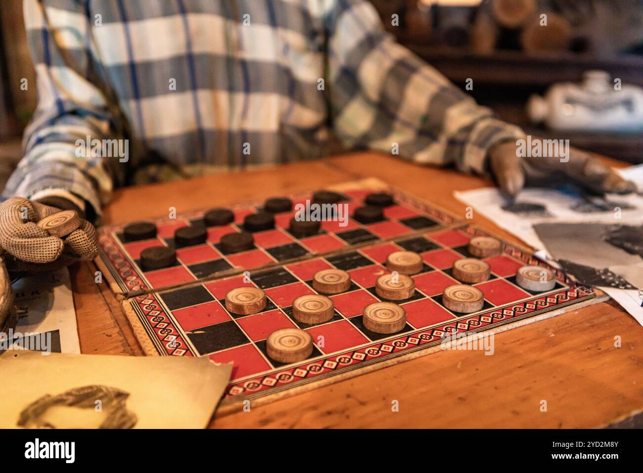 Wax figure of farmer man playing checkers Stock Photo - Alamy