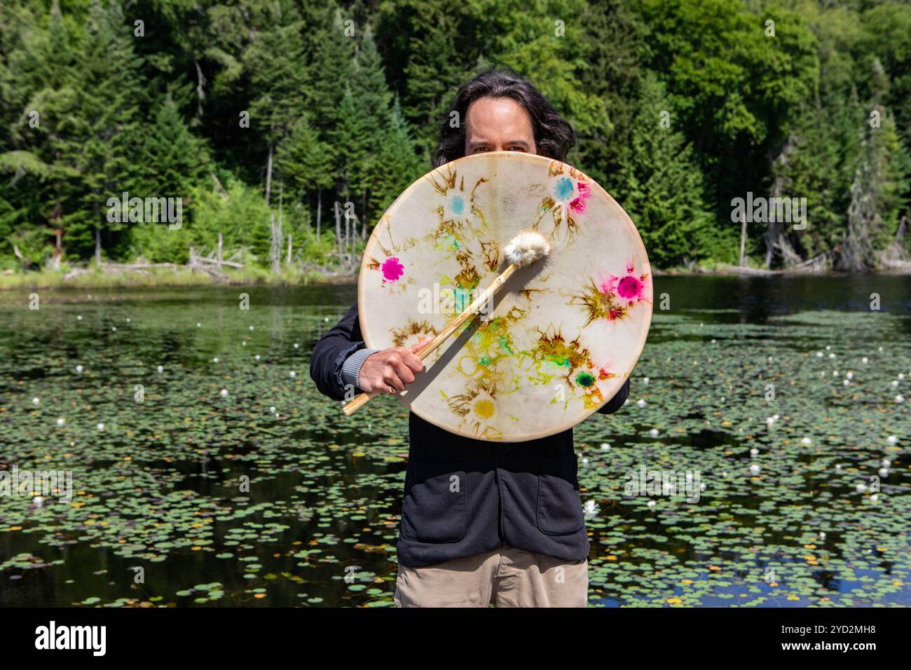 Man cover face with sacred drum and fur stick Stock Photo - Alamy
