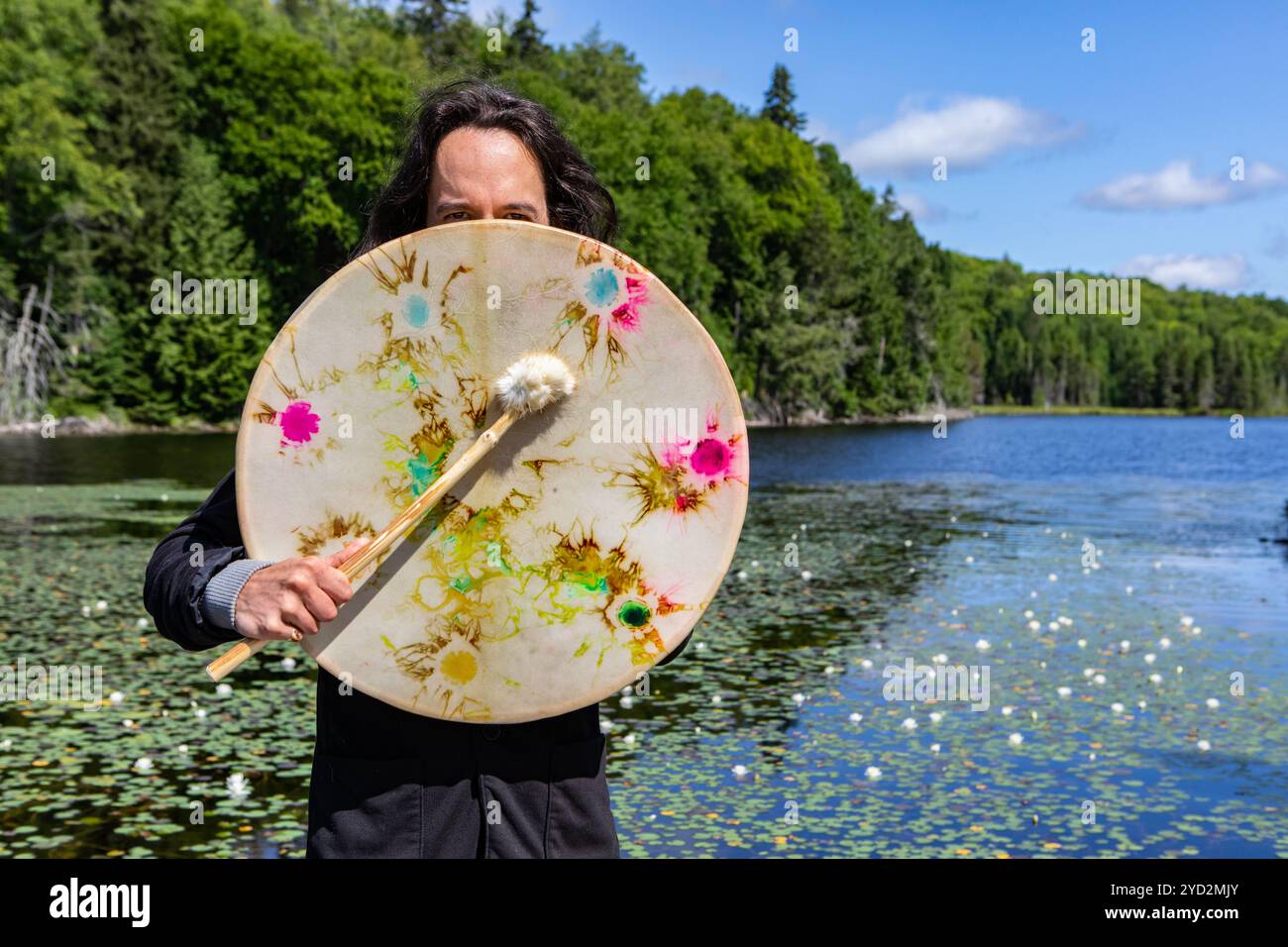 Man cover face with sacred drum and fur stick Stock Photo - Alamy