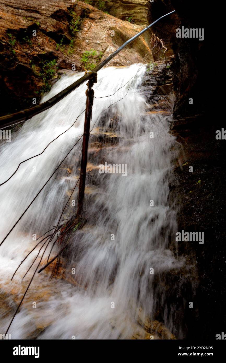 Waterfall overflowing onto the cliff side steps Stock Photo - Alamy