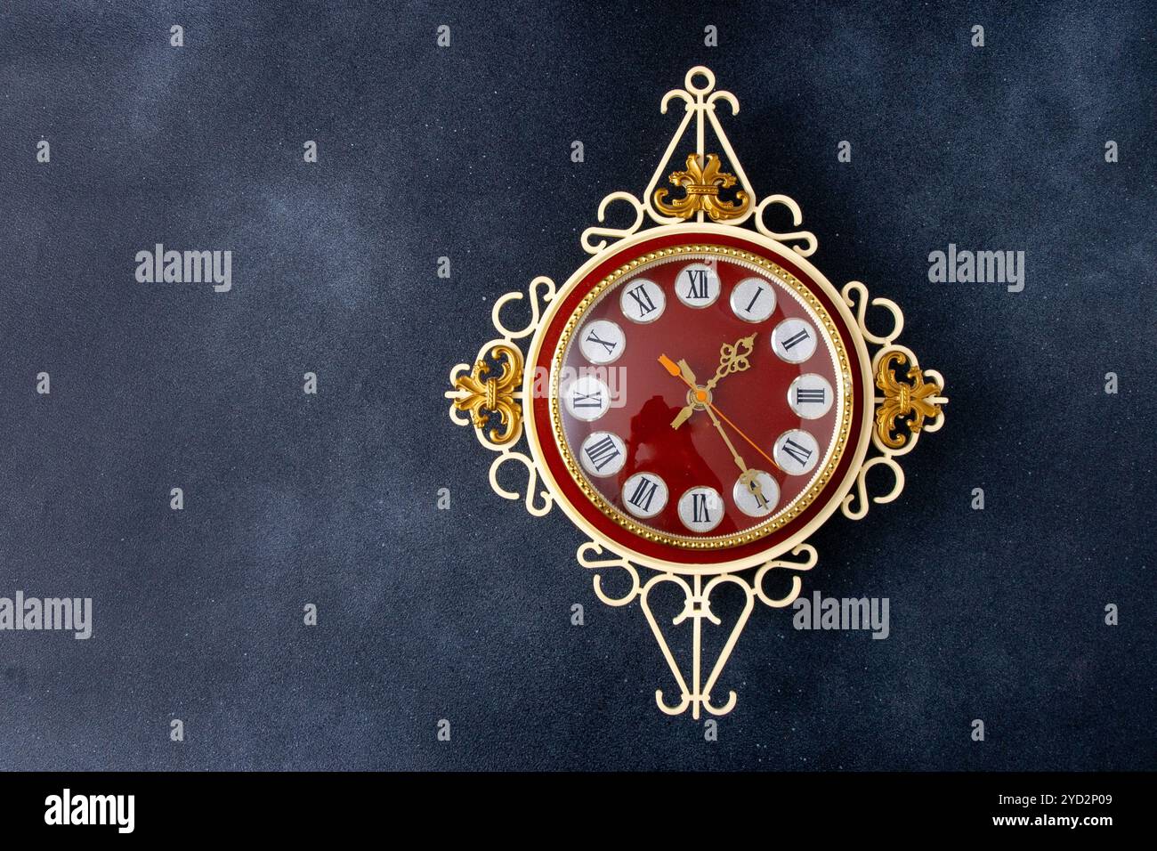 Old wall clock. Hands and Roman numerals on the dial. Black background ...