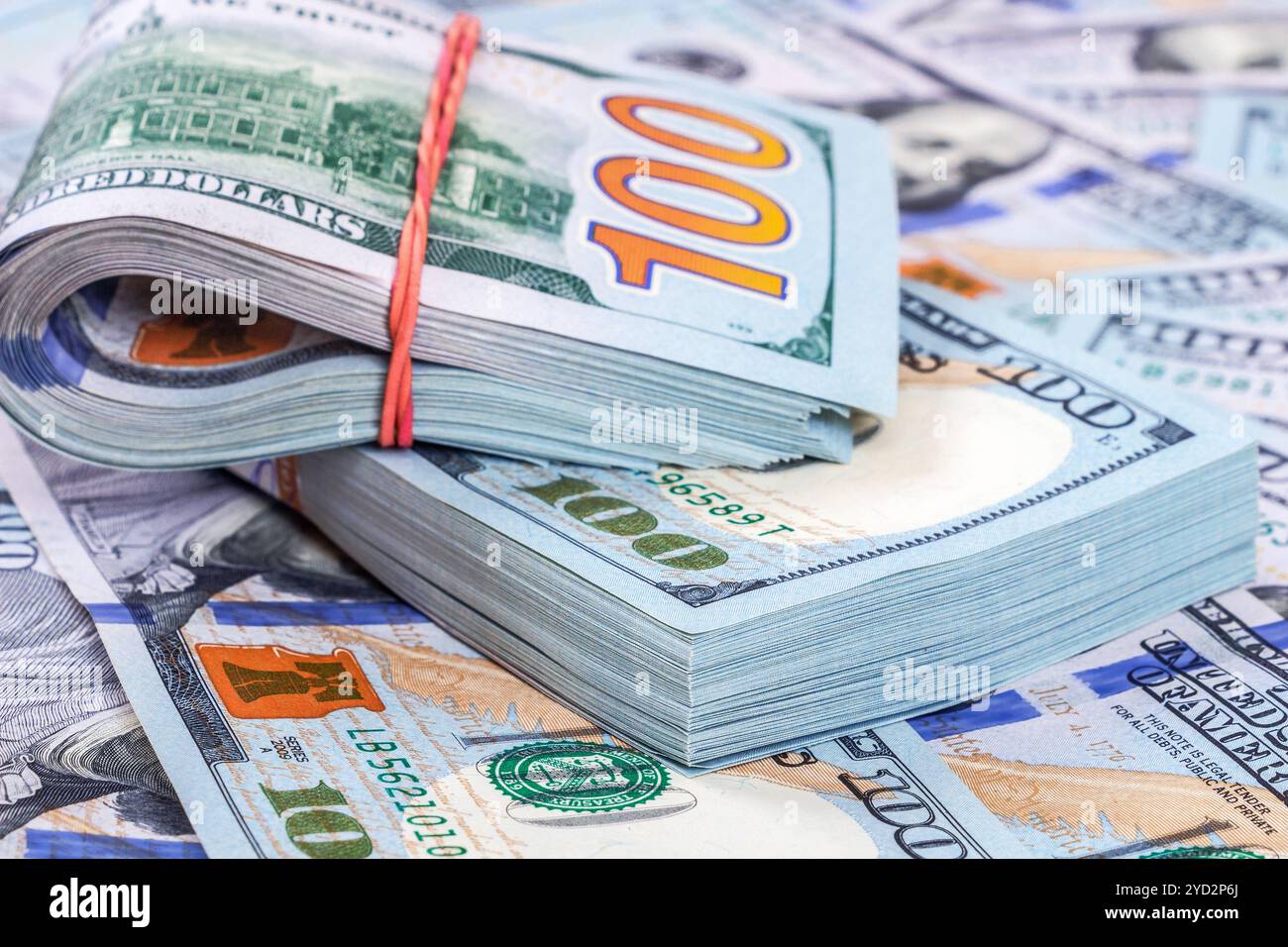 Dollar bills wrapped by rubber band over dollars banknotes Stock Photo ...