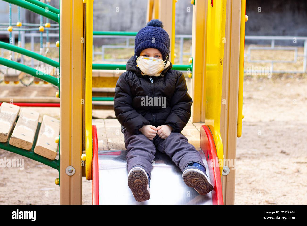 A boy on the Playground in a mask. Health. Coronavirus. Medical mask on ...
