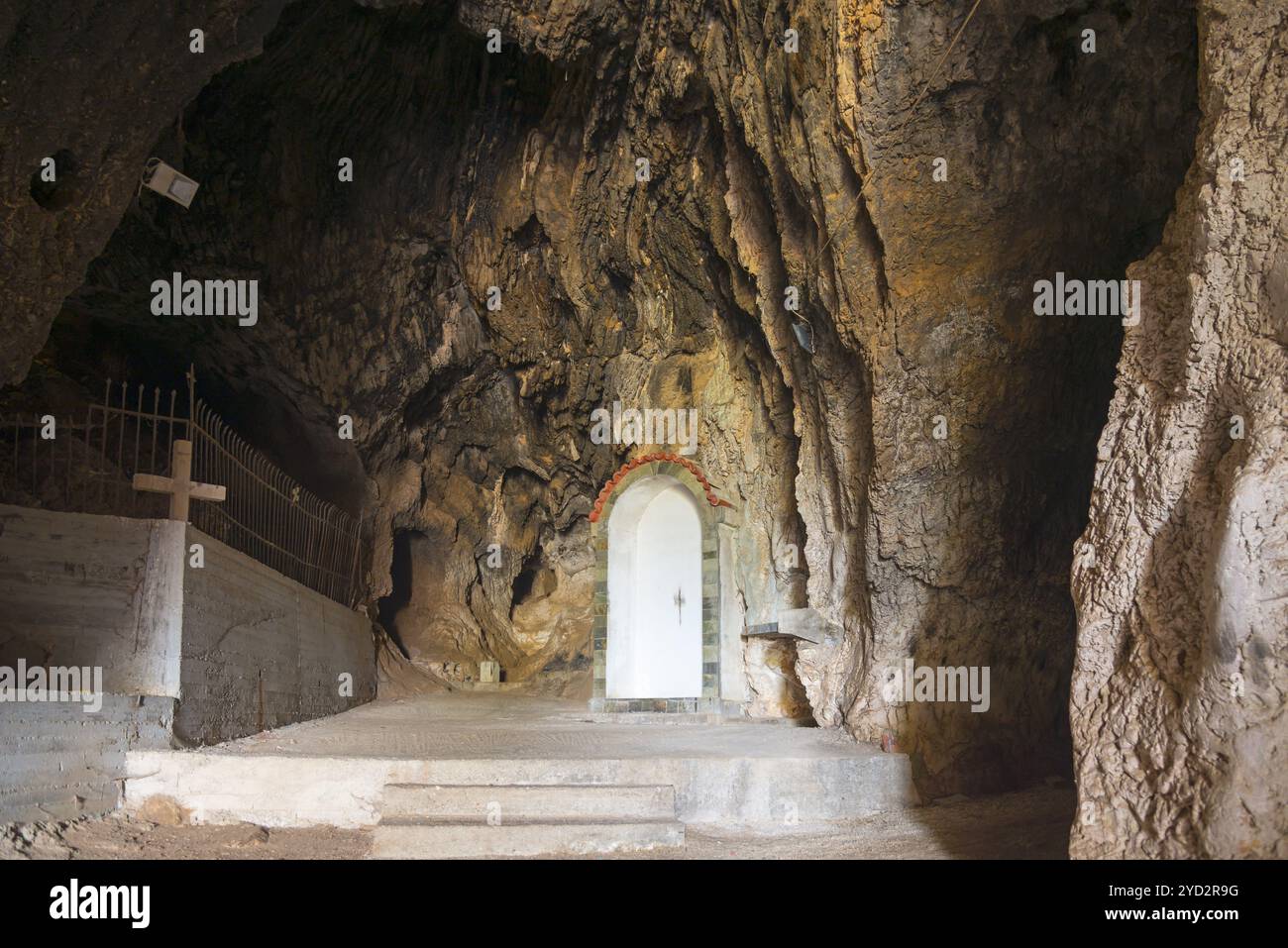 Entrance to cave with play of light, striking rock formation and steps ...