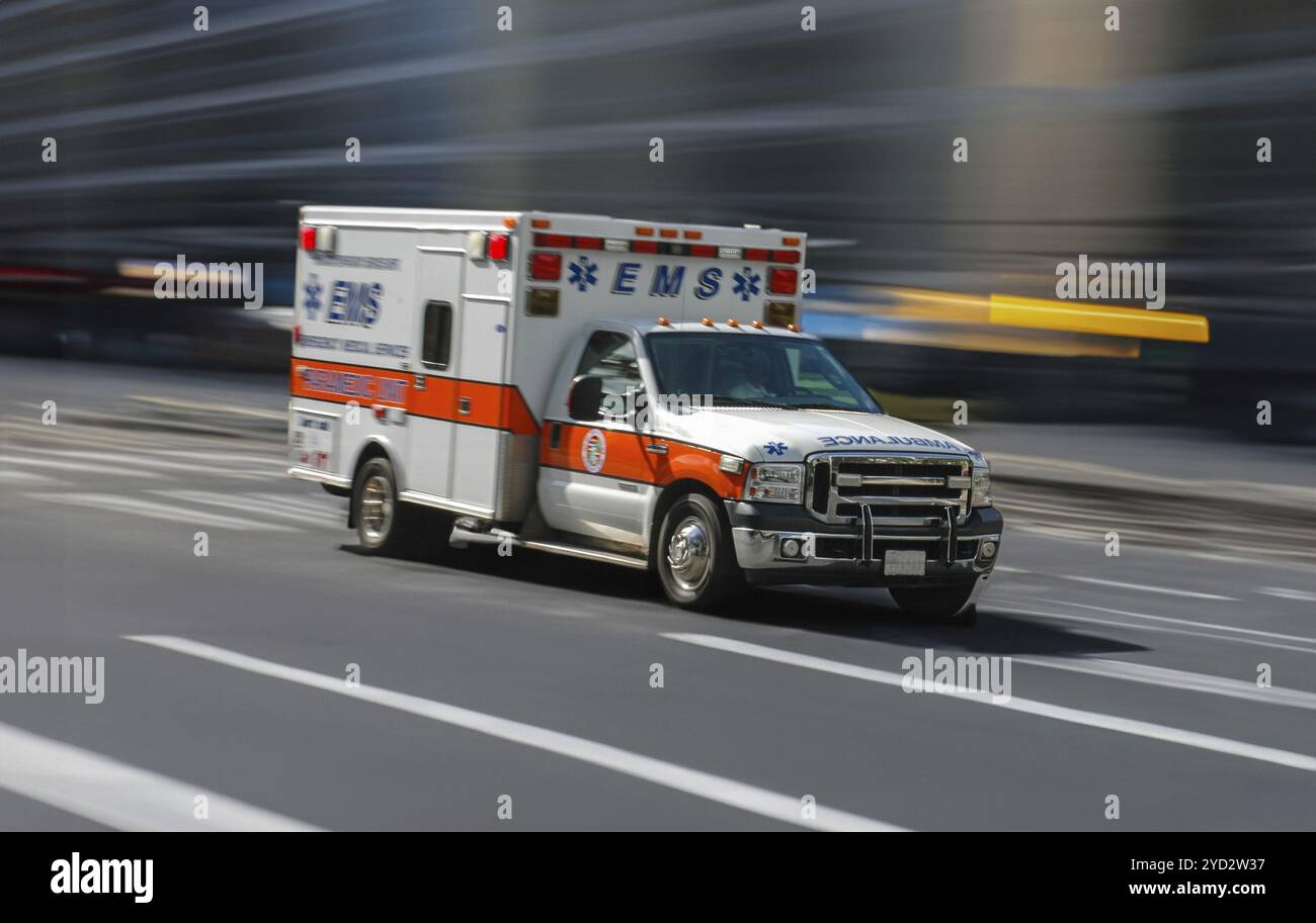 An Ambulance Racing Through A Downtown City Street, With Motion Blur ...