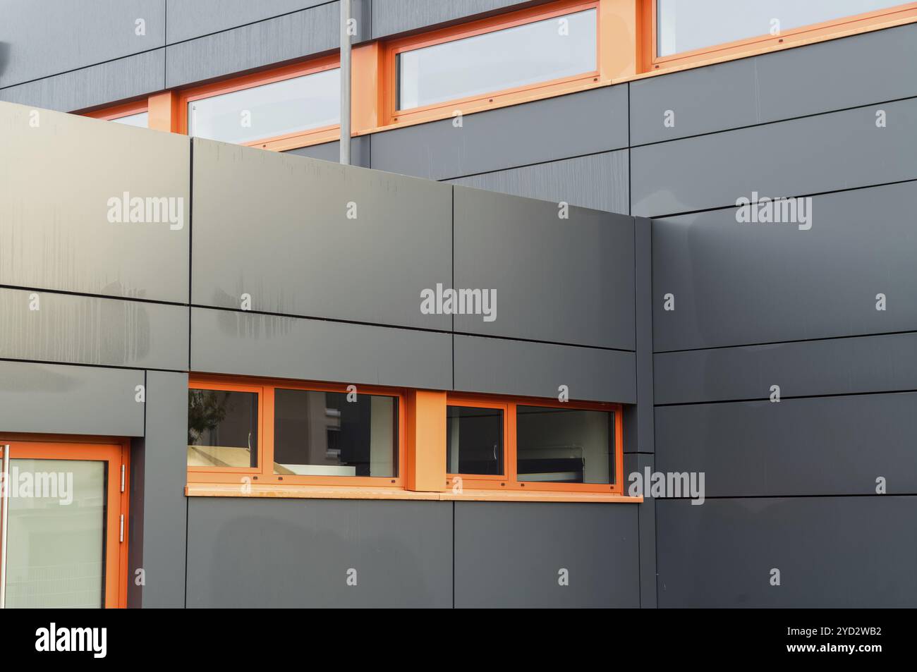 The exterior wall of a modern office building featuring grey cladding ...