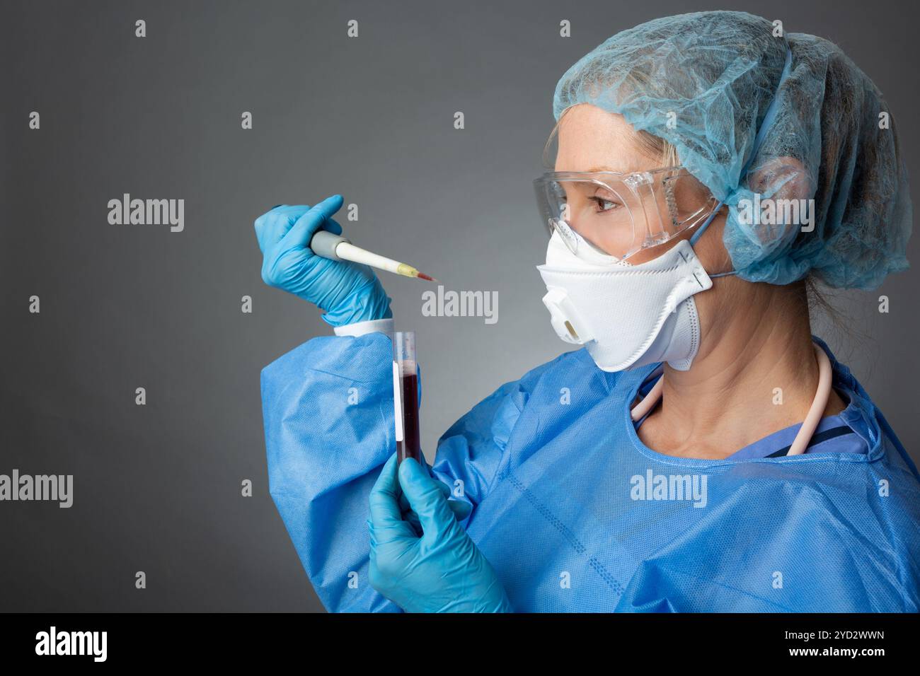 Laboratory healthcare worker holding a pipette blood sample Stock Photo ...