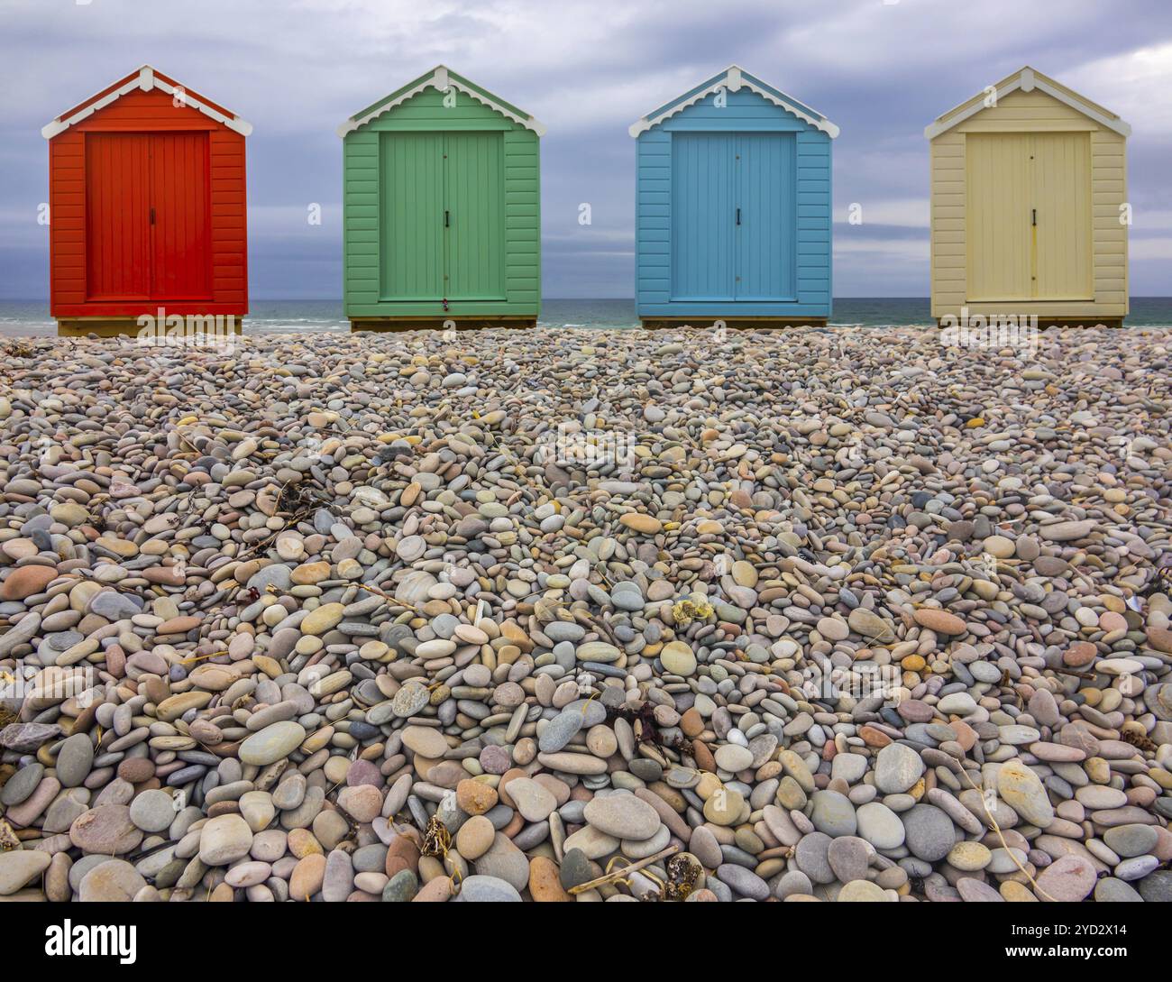 Vintage British Beach Huts On A Stony Shore With Wintry Sky With Copy ...