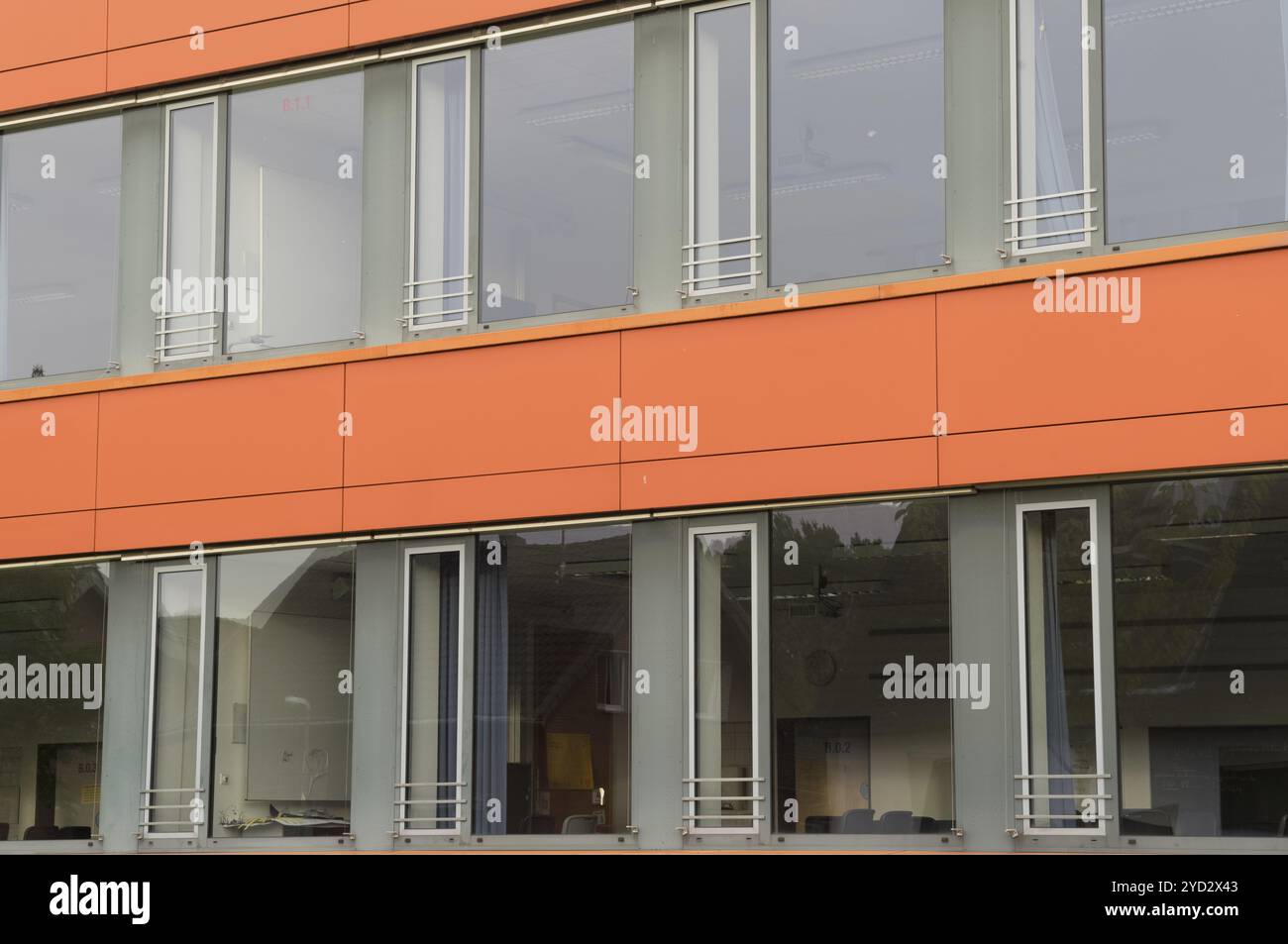 Sunlight reflecting off the large windows of a modern office building ...