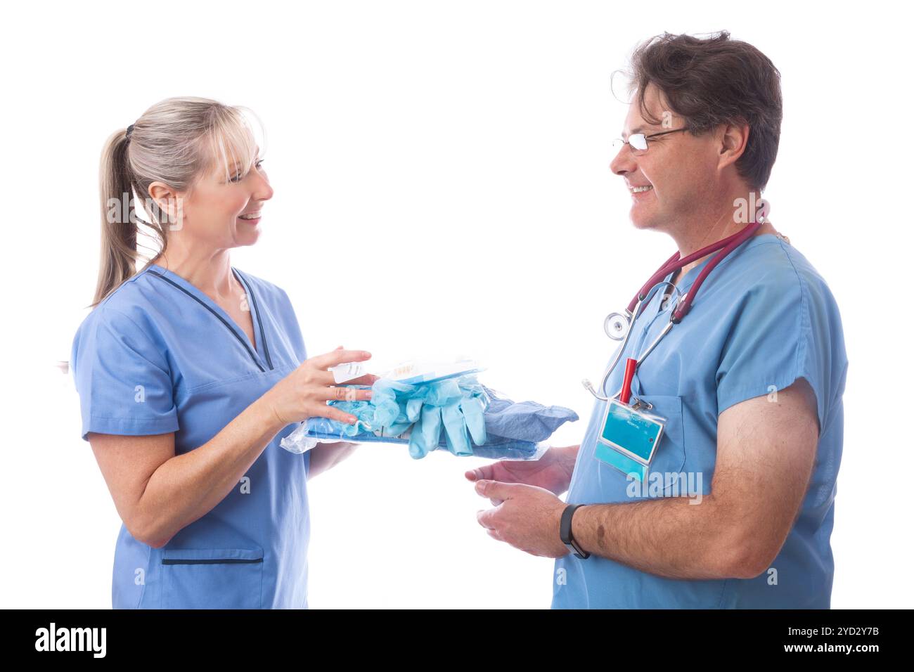 Hospital healthcare worker hands a PPE kit to another nurse or doctor ...