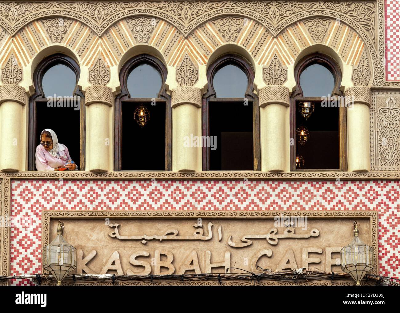 Marrakesh, Morocco, 23 March, 2024: Muslim woman observing city life and looking out the ...