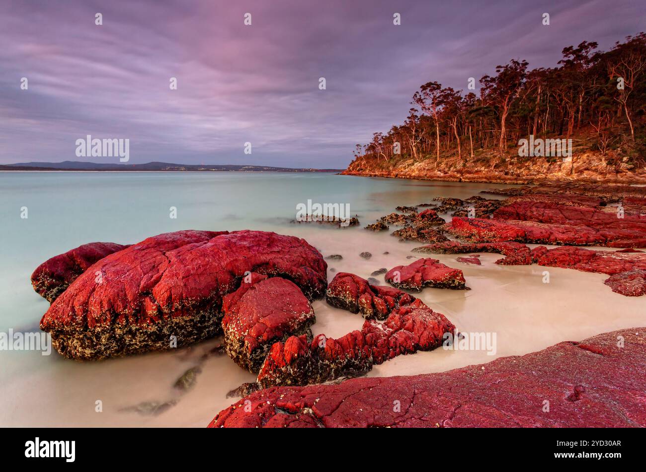 Sunset sky highlighting the red rocks and blue water of Eden Stock ...