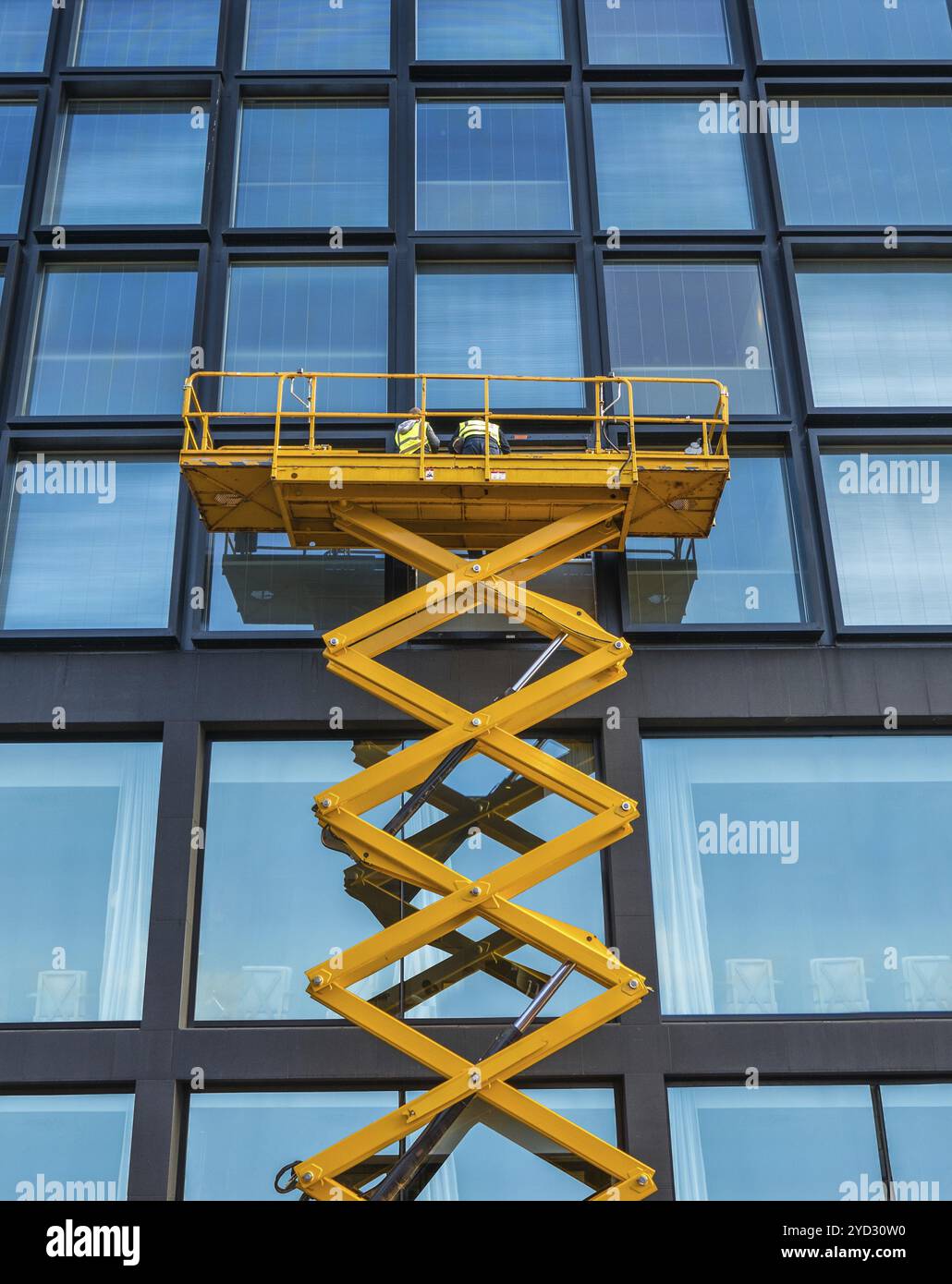 Workers On A Scissor Lift Cleaning Windows On A Financial Building ...