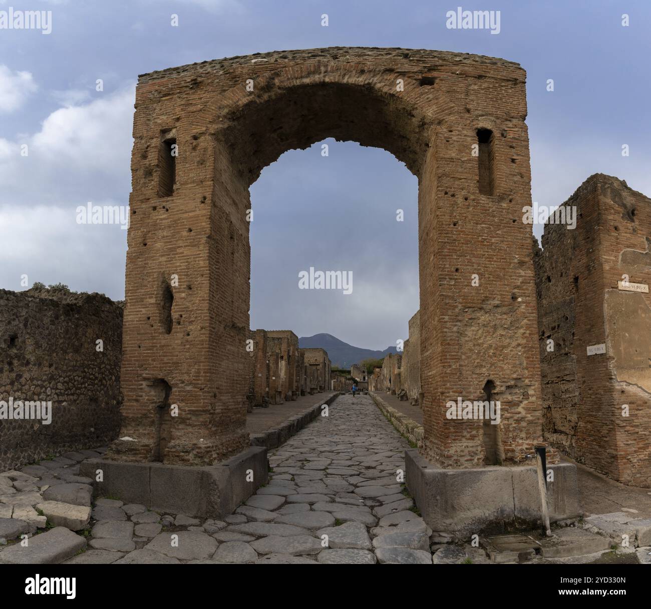 Pompei, Italy, 25 November, 2023: stone arch and long street in the ...