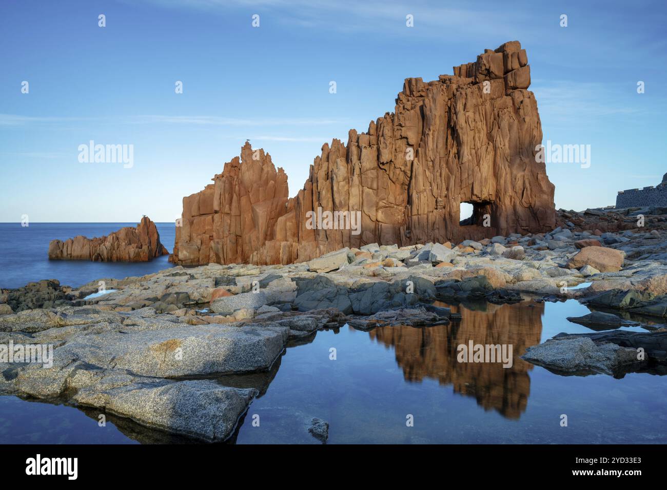 A view of the red rocks of Arbatax with reflections in tidal pools in ...
