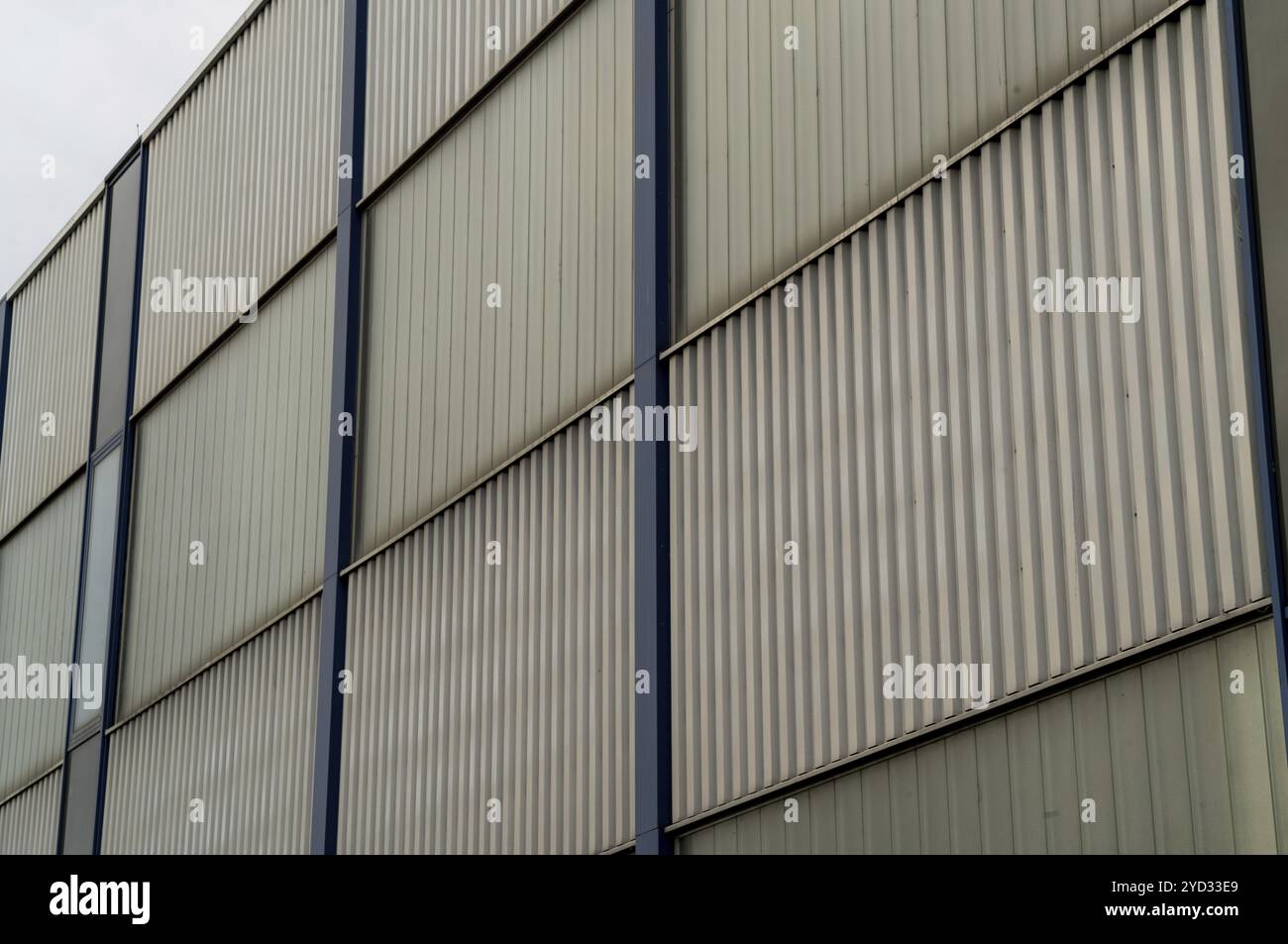 Modern building facade with metal panels and glass windows that form a ...