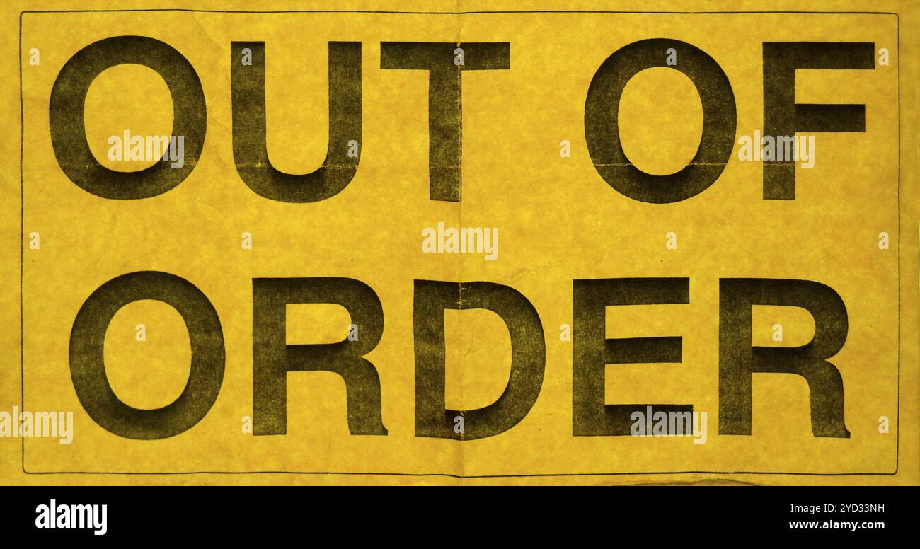Grungy Yellow Out Of Order Sign Posted On A Wall Stock Photo - Alamy