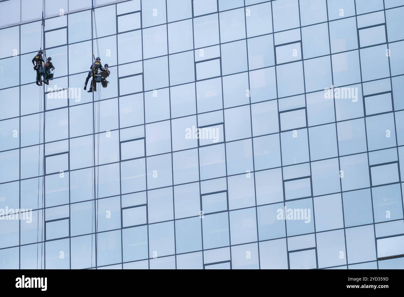 Two Worker Cleaning The Windows Of A High Rise Building Or Skyscraper ...
