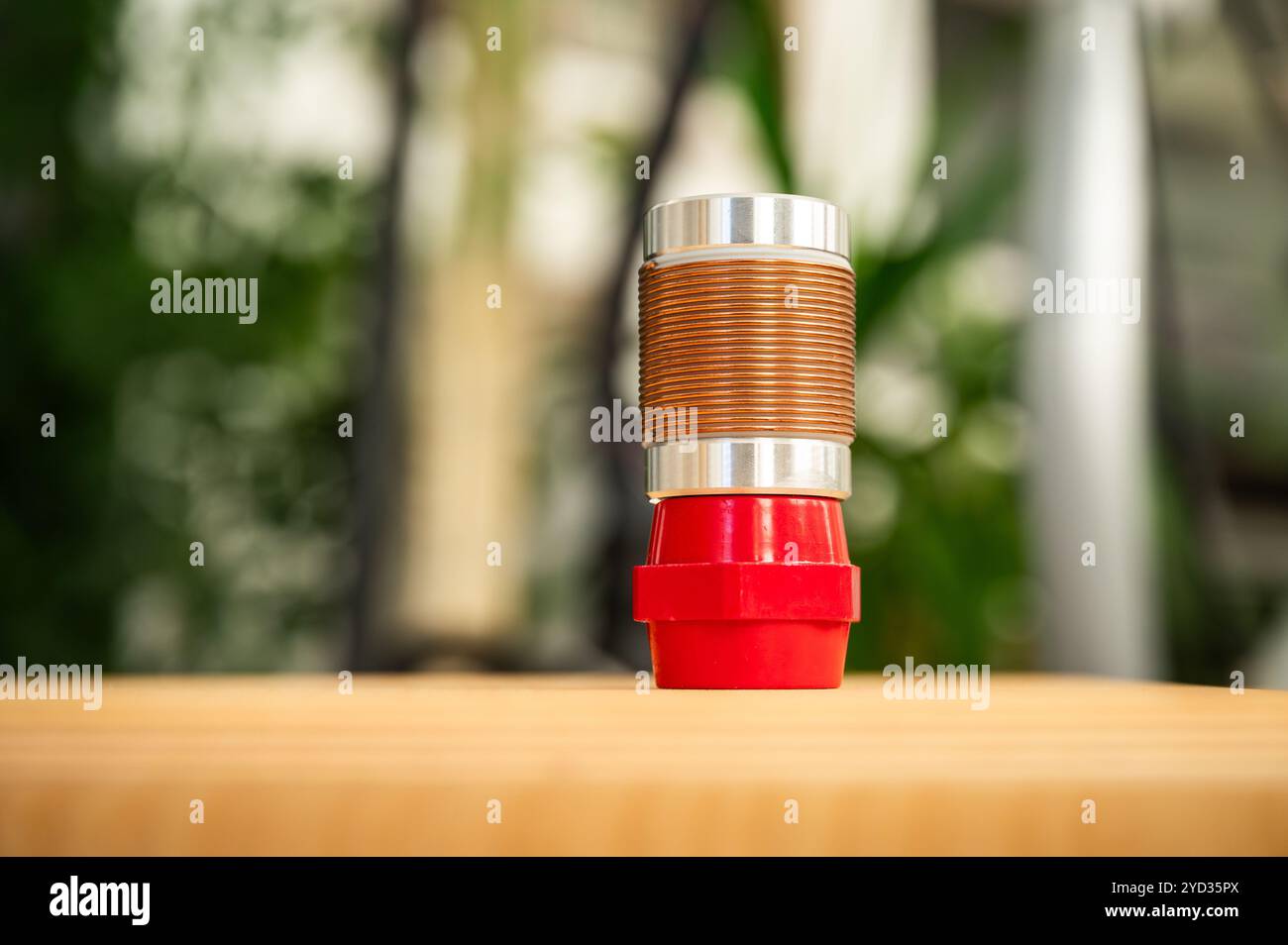 Electrotechnical coil made of copper wire for high frequency on a red ...