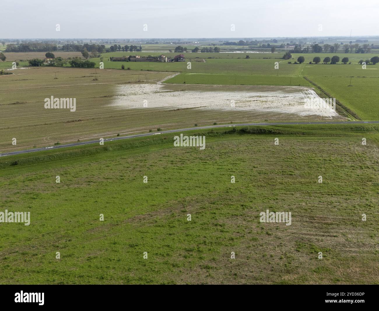 Aerial view of flooded field with tractor tracks after heavy rain ...