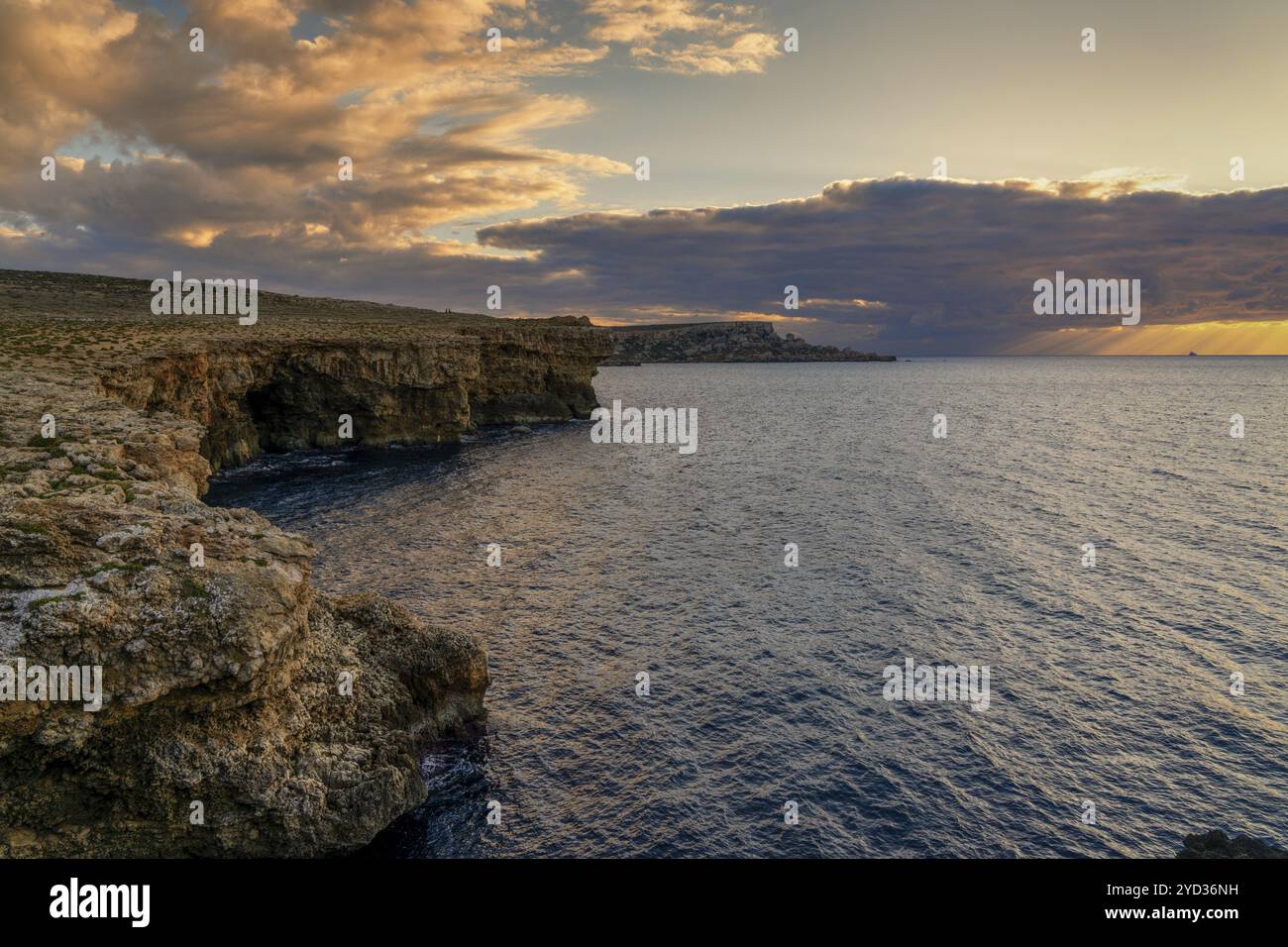 A sunset seascape in Malta with the Popeye Cliffs and a view of the ...