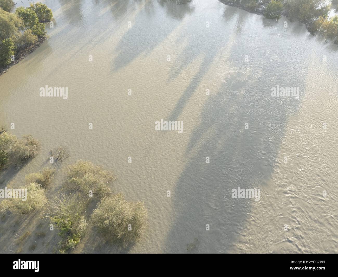 Aerial view of muddy water flowing over the Po riverbanks covering the ...