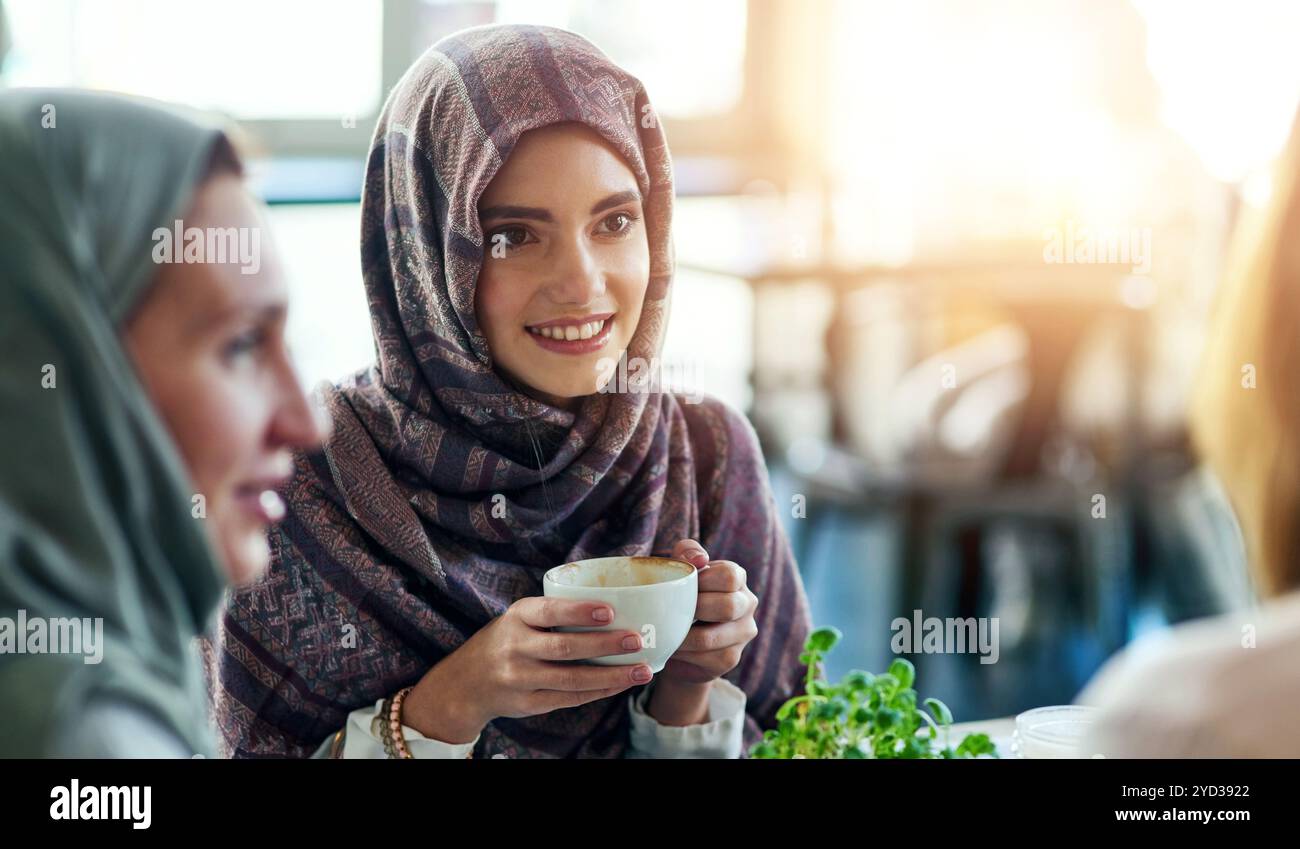 Friends, smile and Muslim women in coffee shop, bonding and talking ...