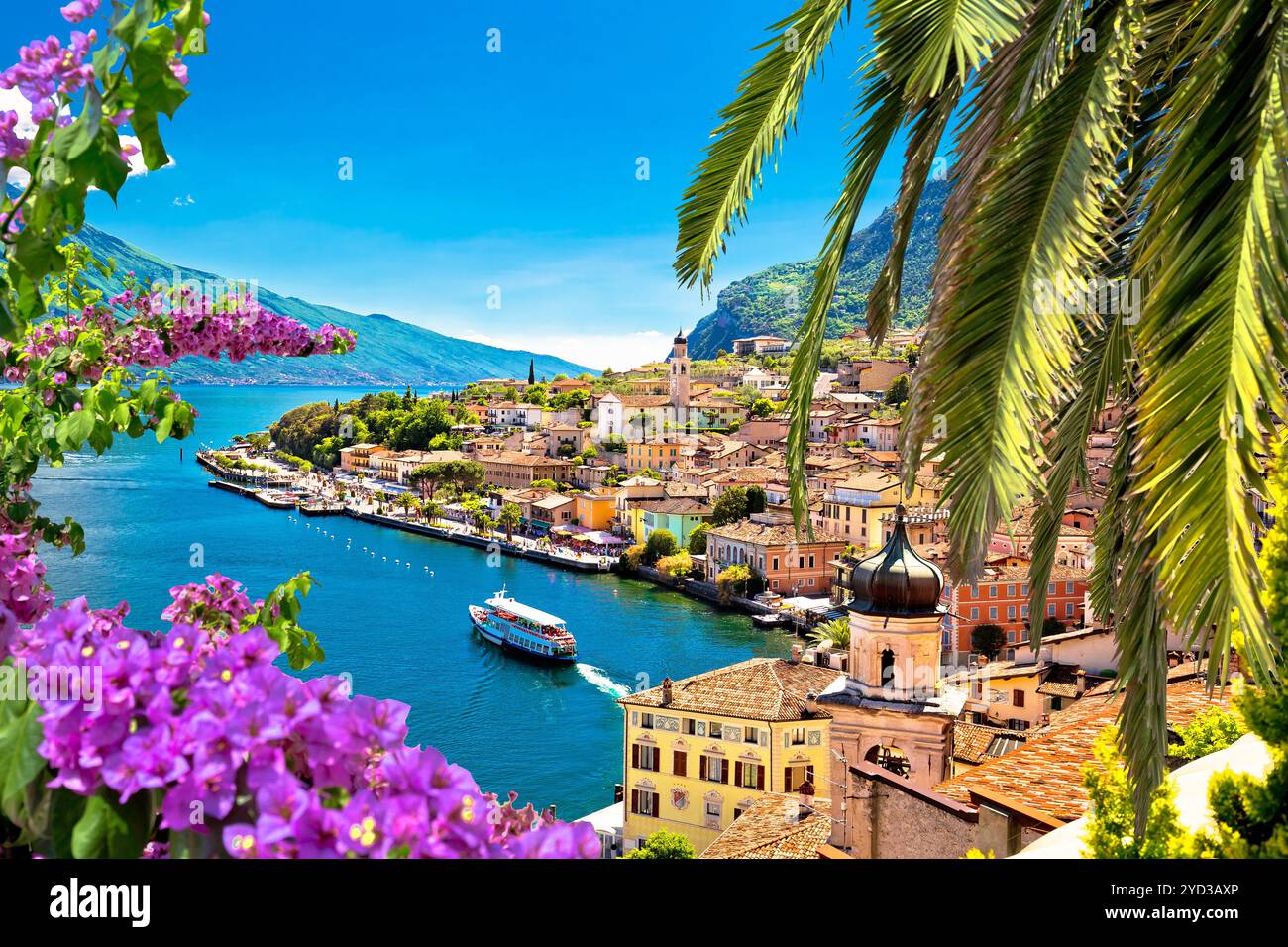 Limone sul Garda waterfront viewthrough flowers and palm tree Stock ...